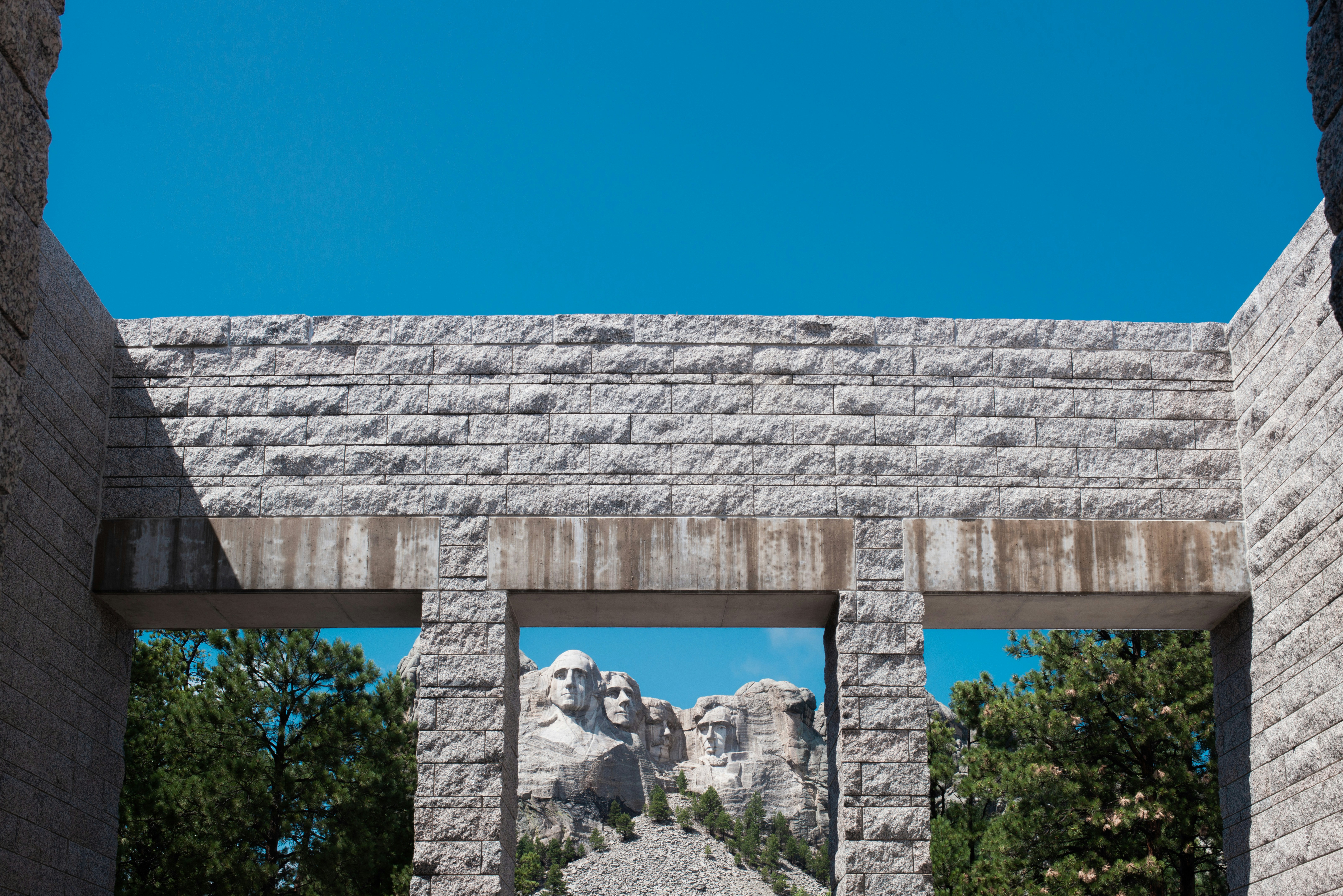 Stone Gateways to Granite Faces: Mount Rushmore Framed by a Concrete Vista