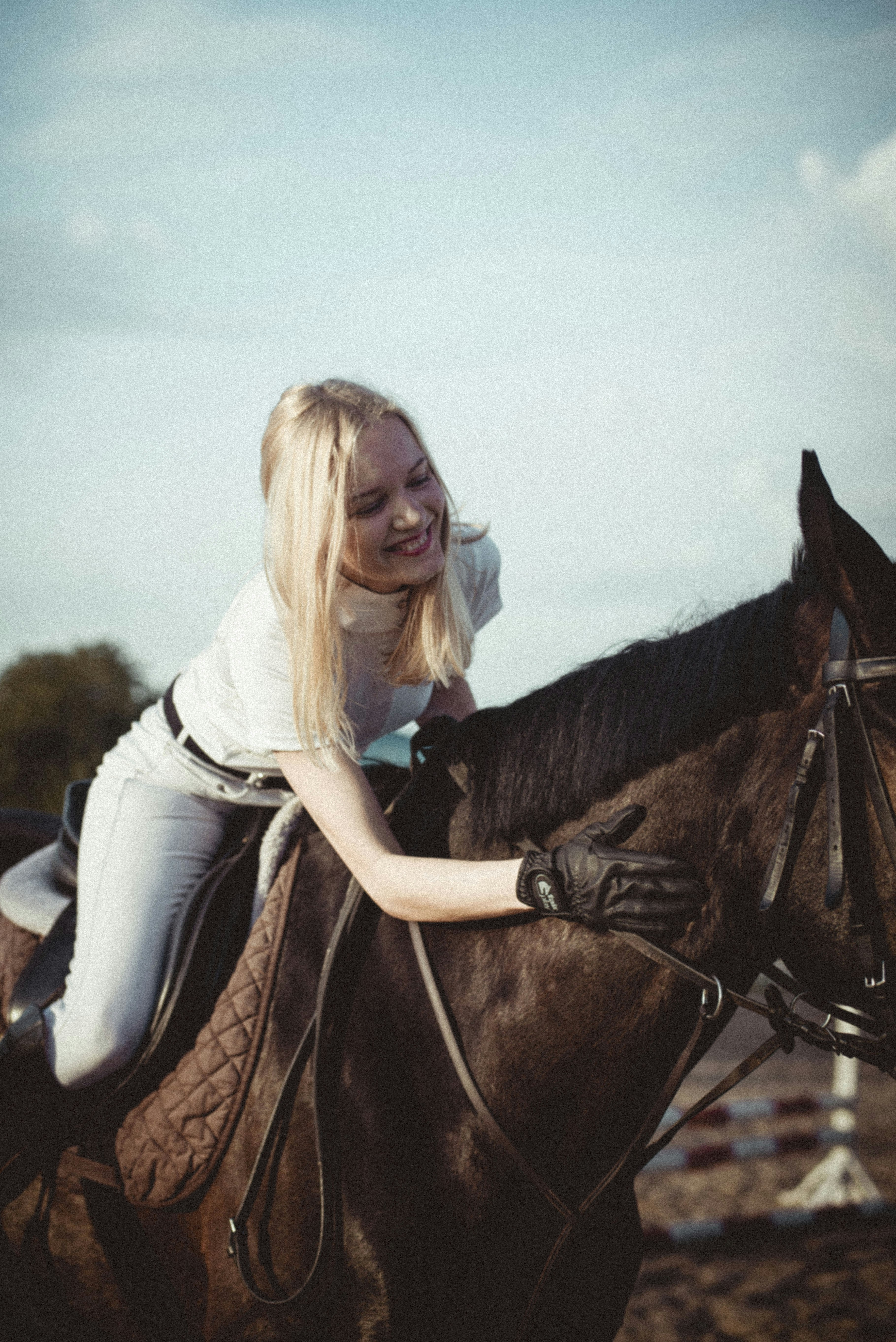 Noon Light, Soft Grin: A Rider's Moment on a Dark Horse
