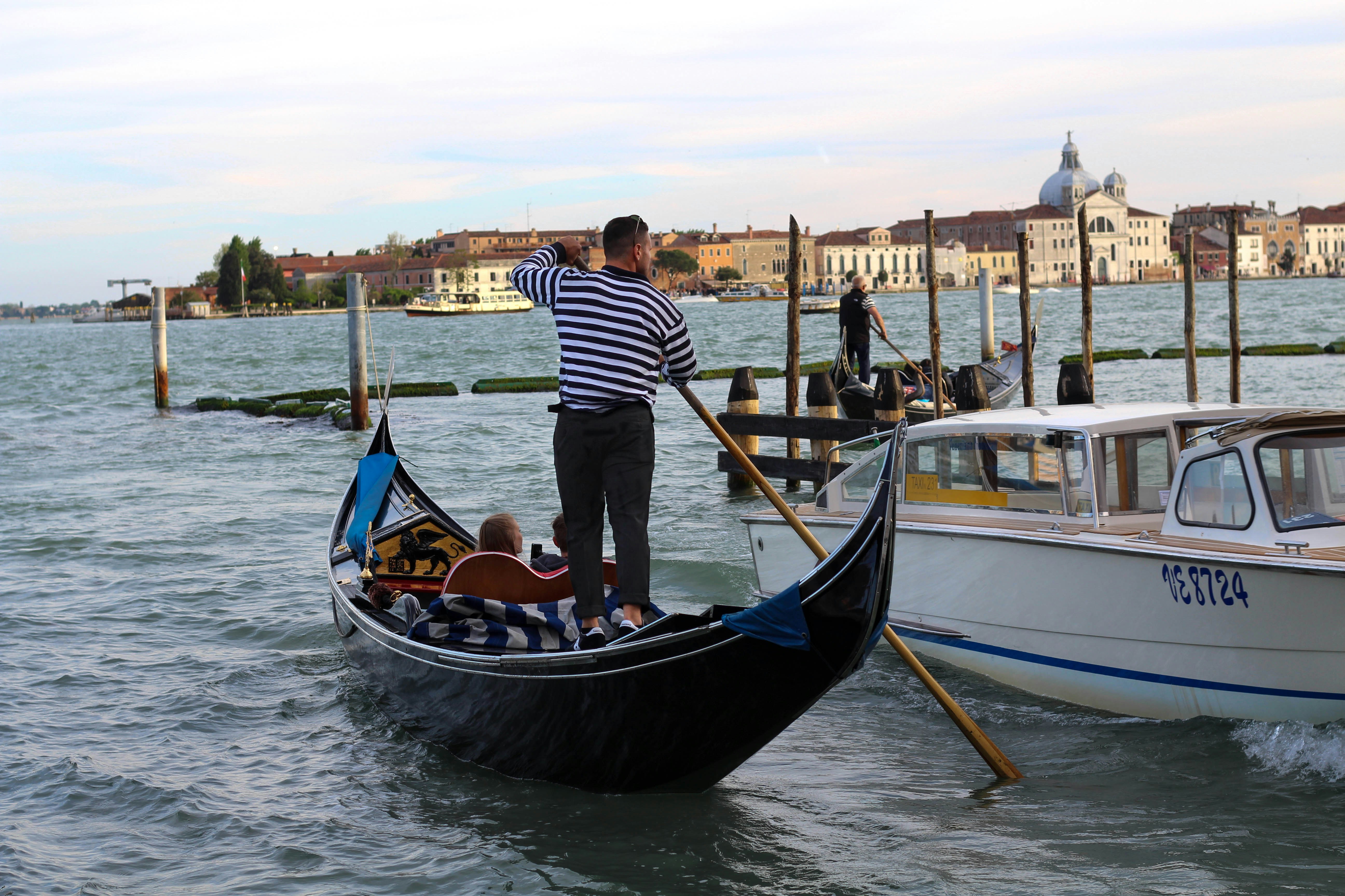Striped Helm: A Gondolier Guiding Through Venetian Waters