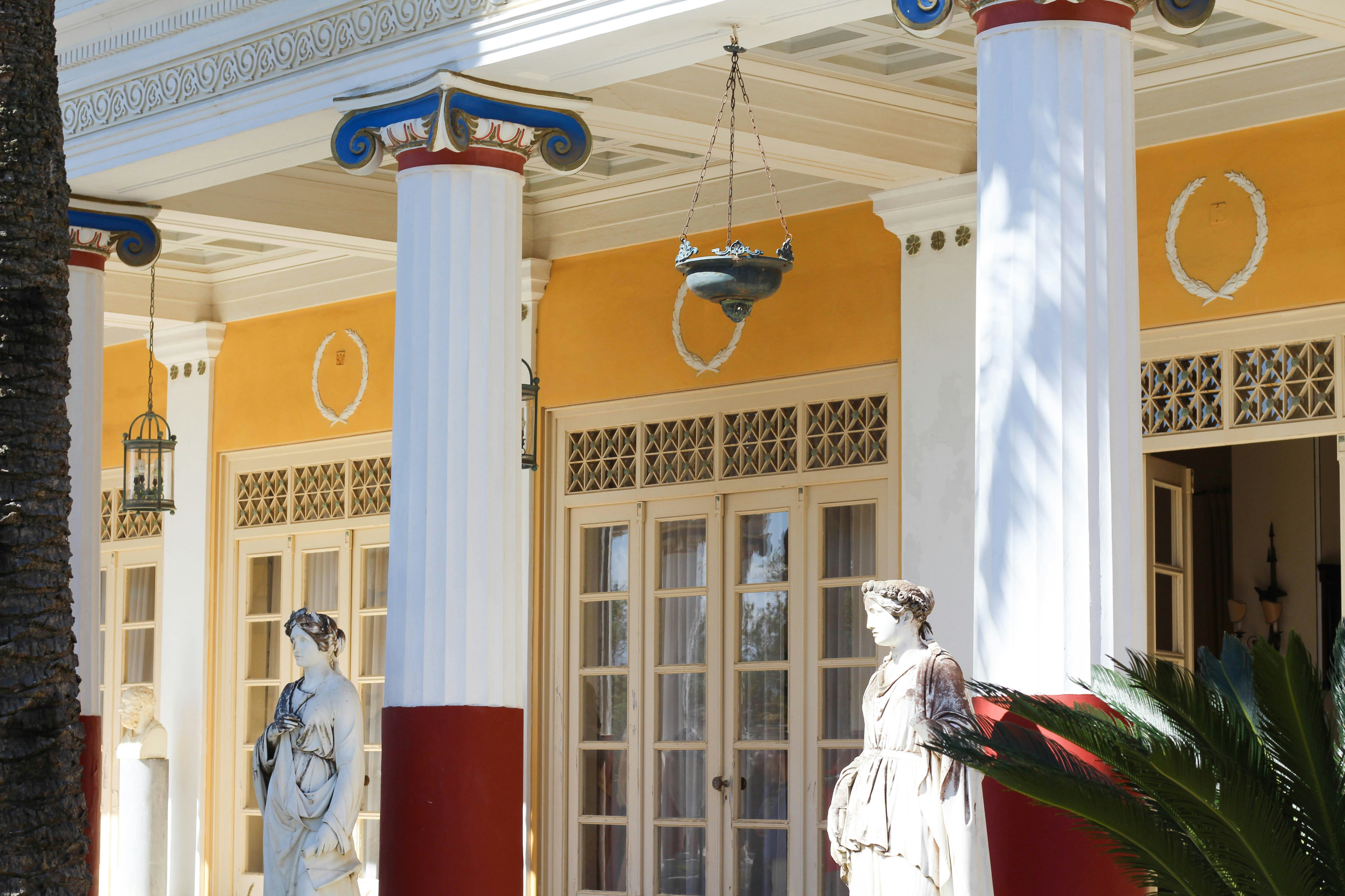 Sunlit Veranda: White Columns Framing a Yellow Facade