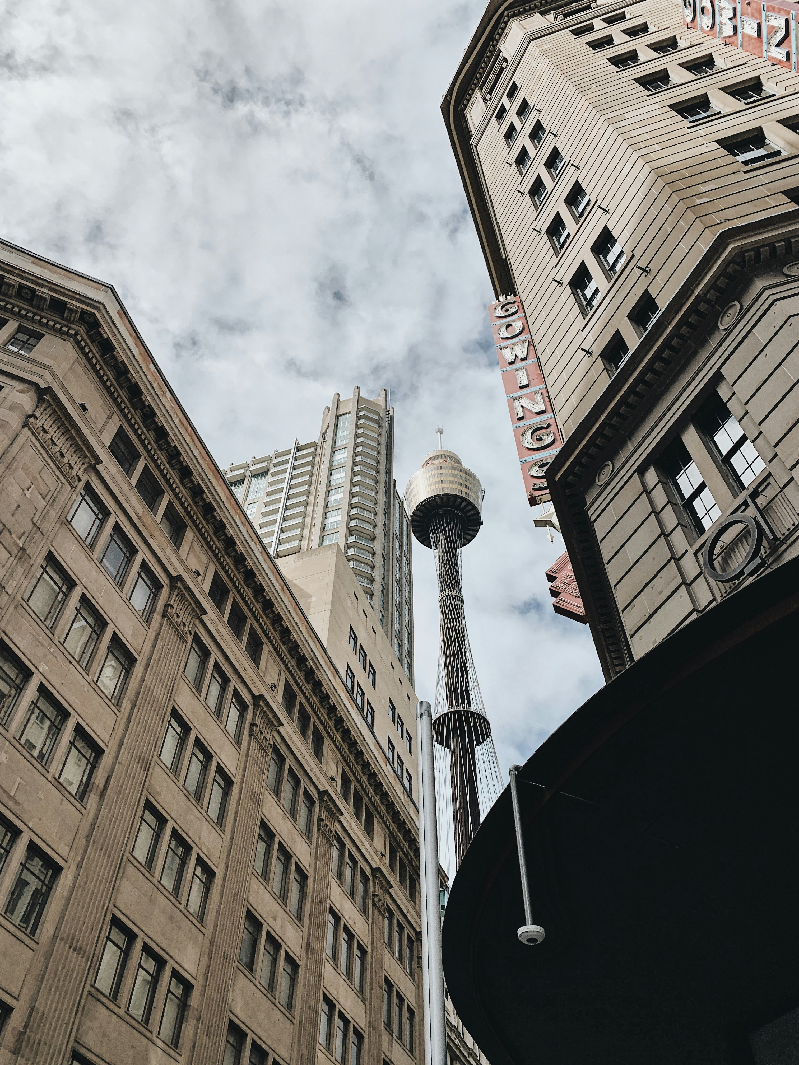 Between Historic Facades, the Pearl Tower Rises: A Low-Angle Cityscape