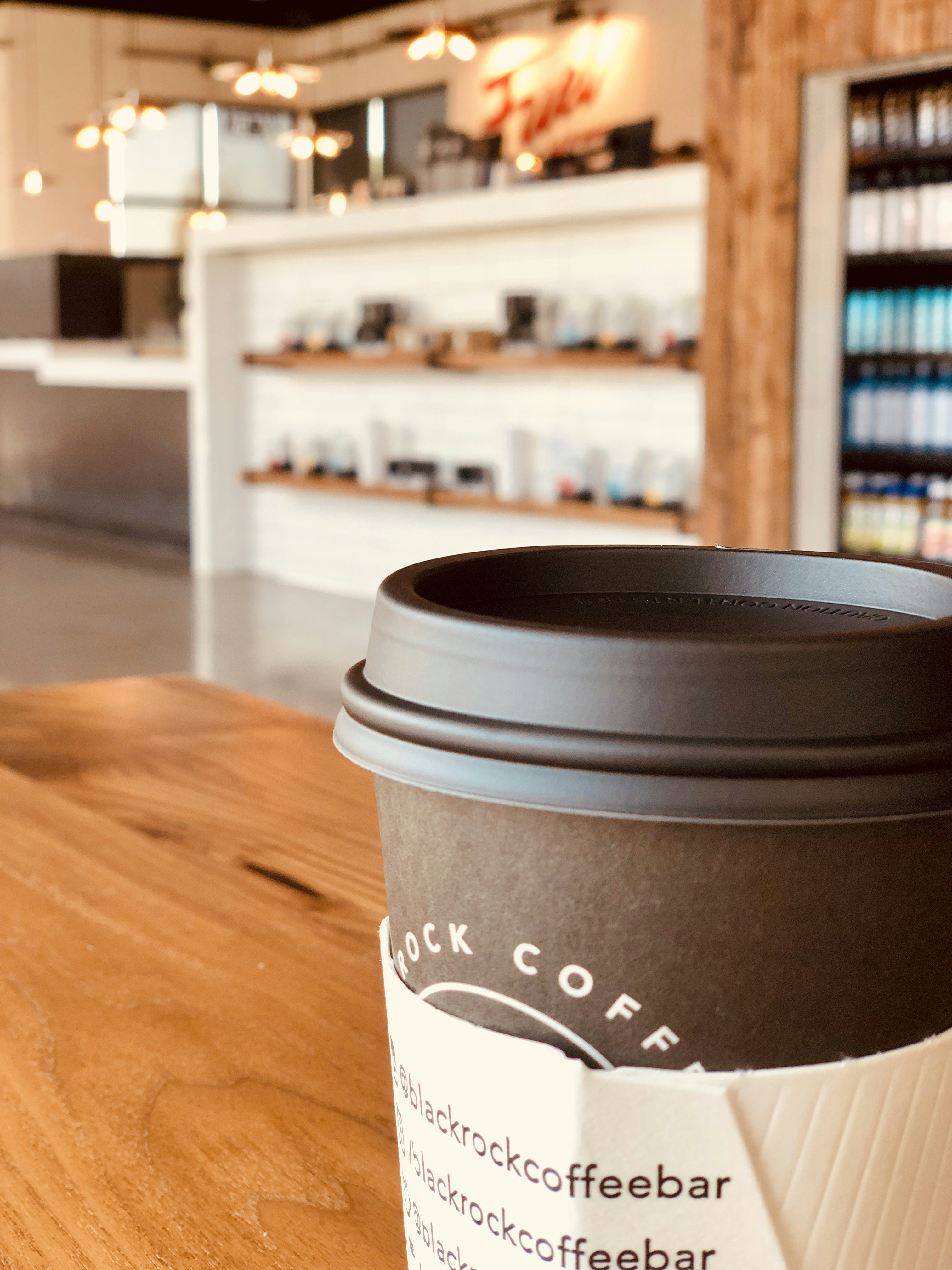 To-Go Morning: A Coffee Cup Close-Up in a Cozy Café Scene
