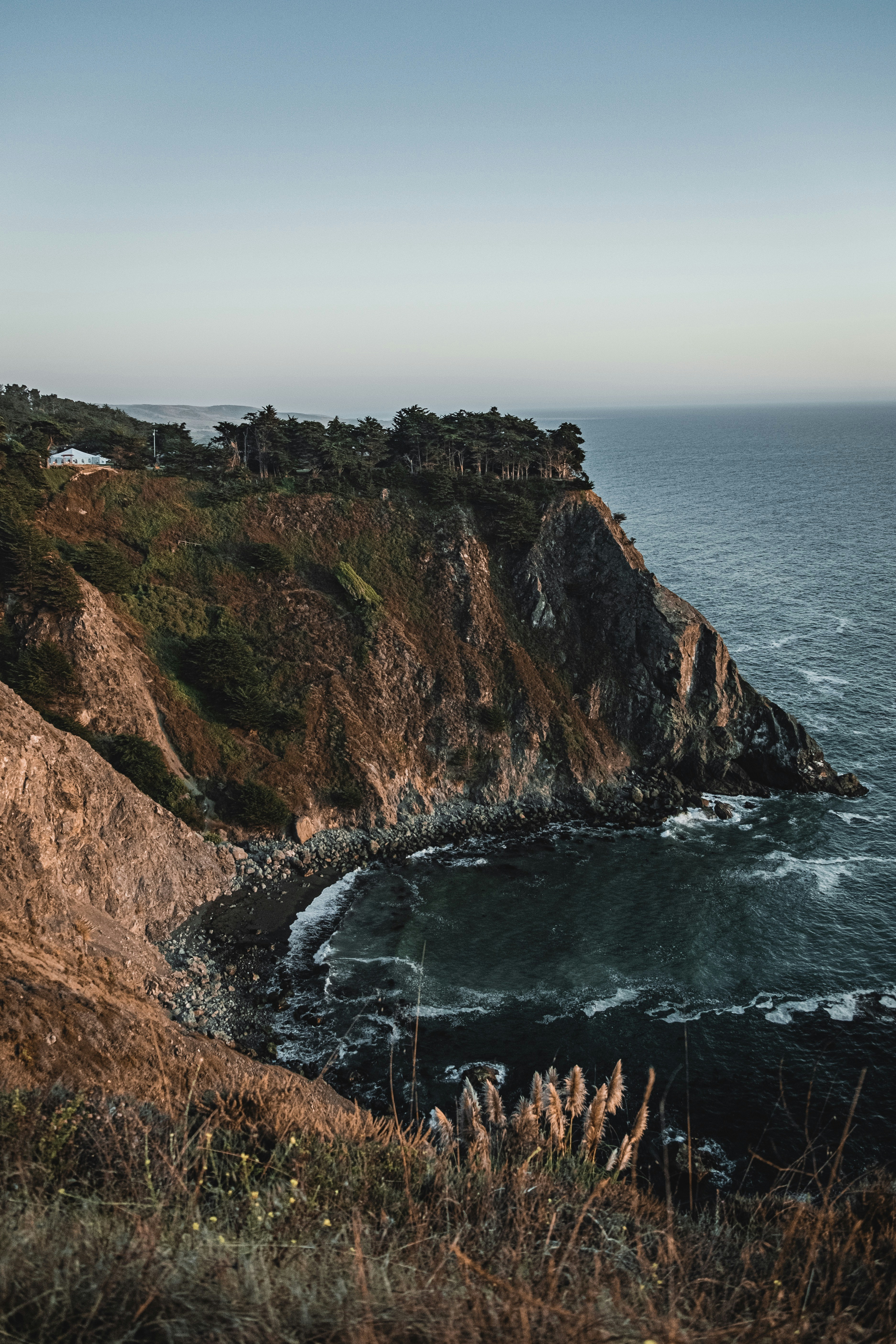 Green grass and rocky mountain island during day photo – Free Nature ...
