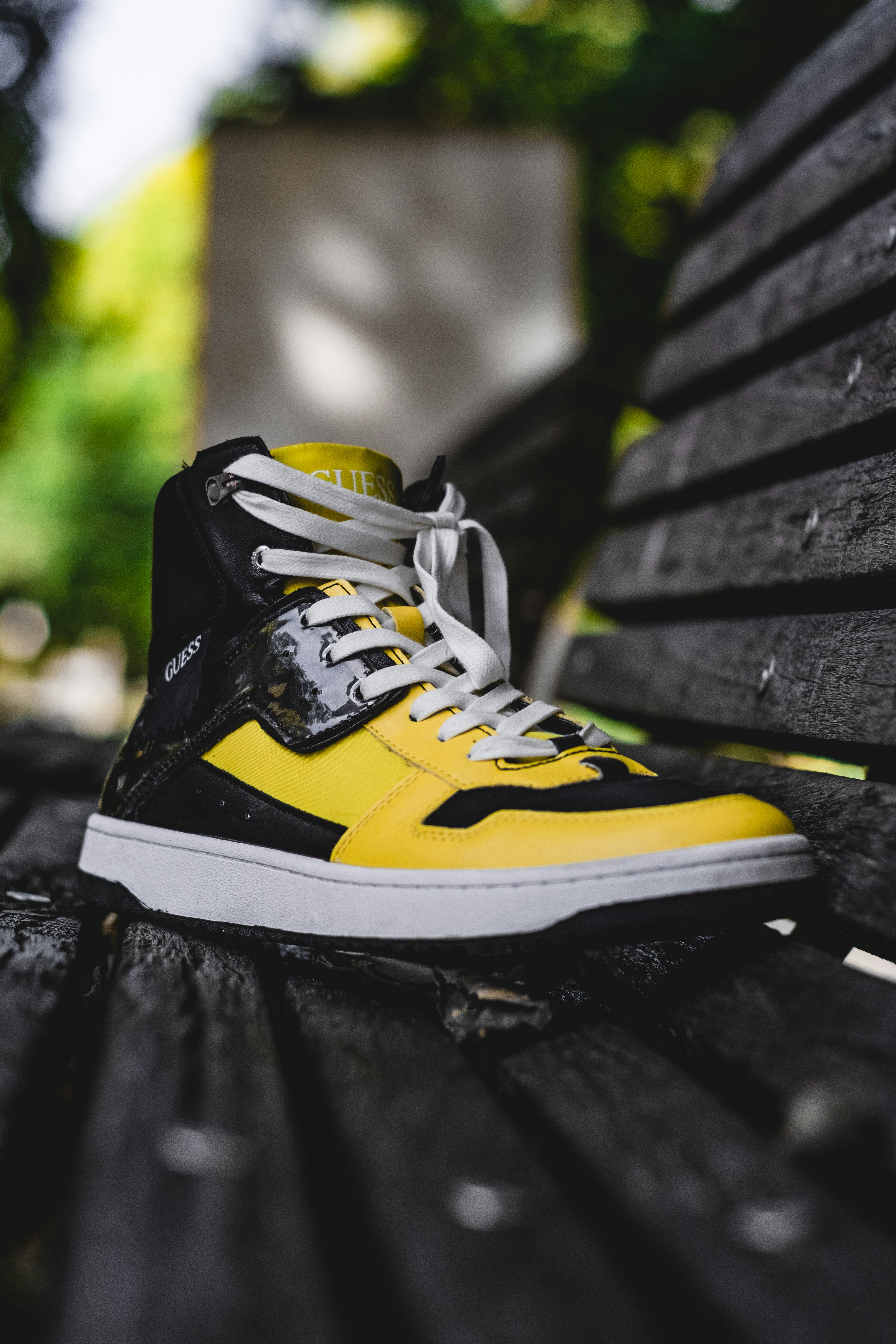 Bold Yellow on Weathered Wood: Close-Up of a High-Top Sneaker