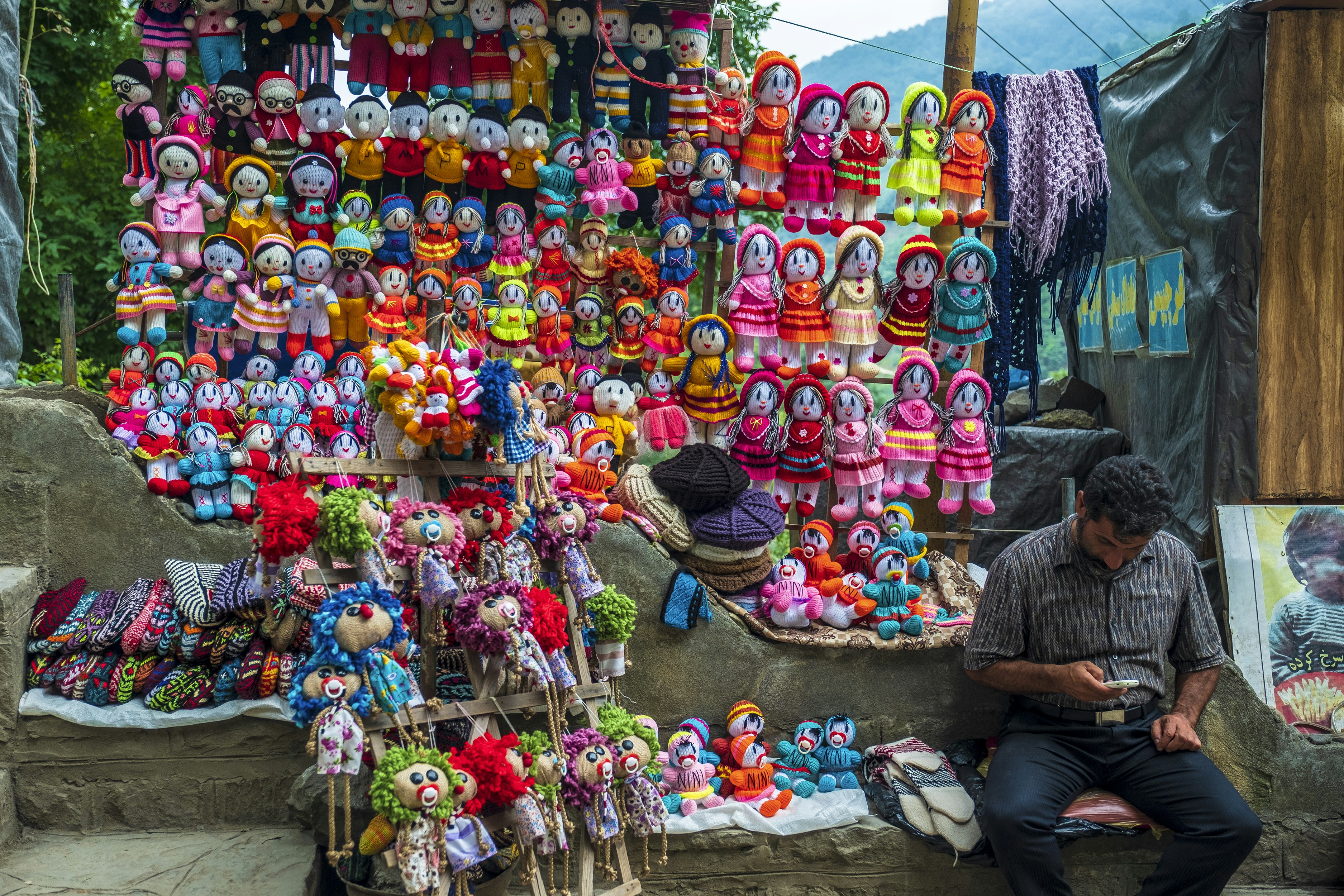 Man sitting beside assorted-color display item photo – Free Masooleh ...