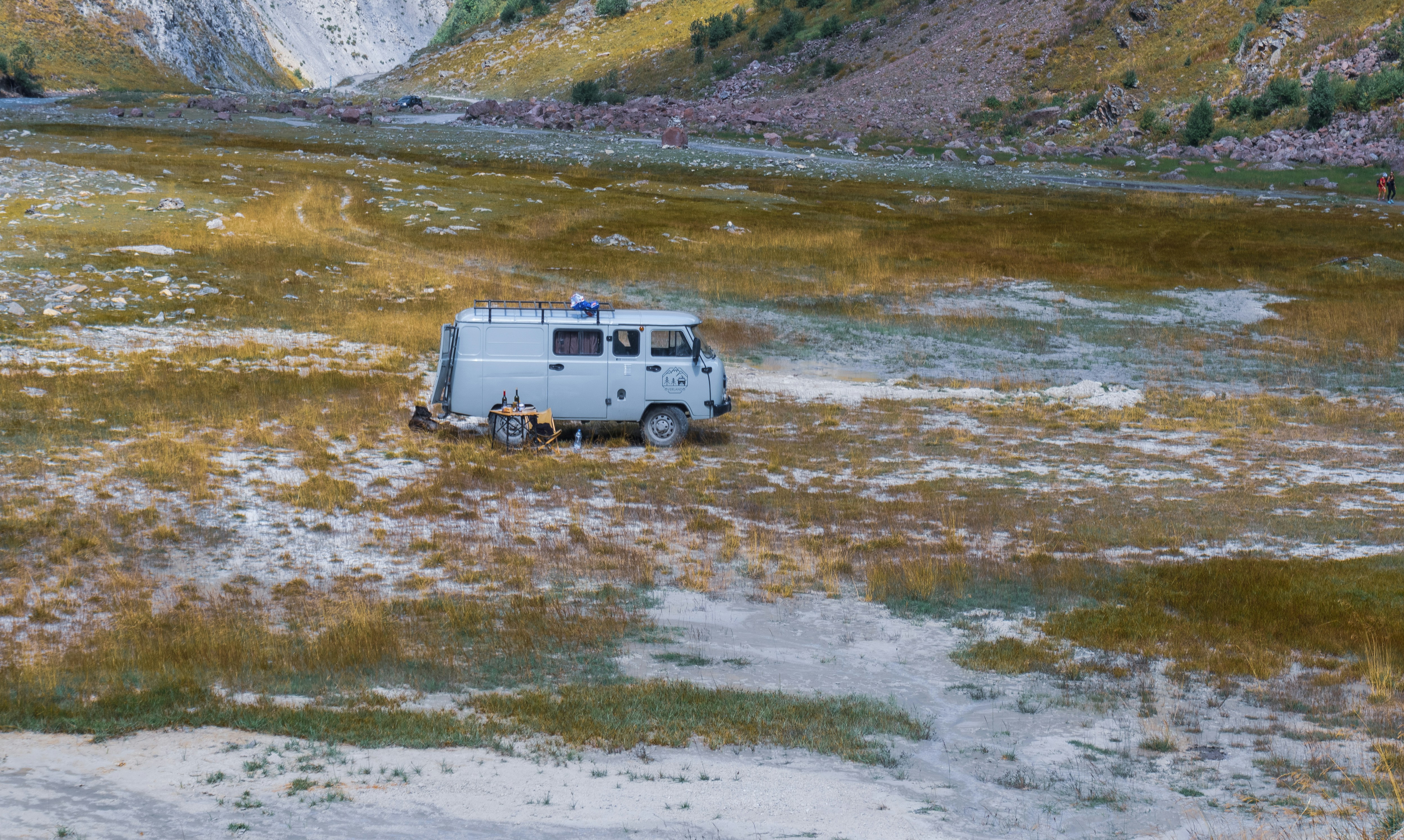 a van is parked in the middle of a field