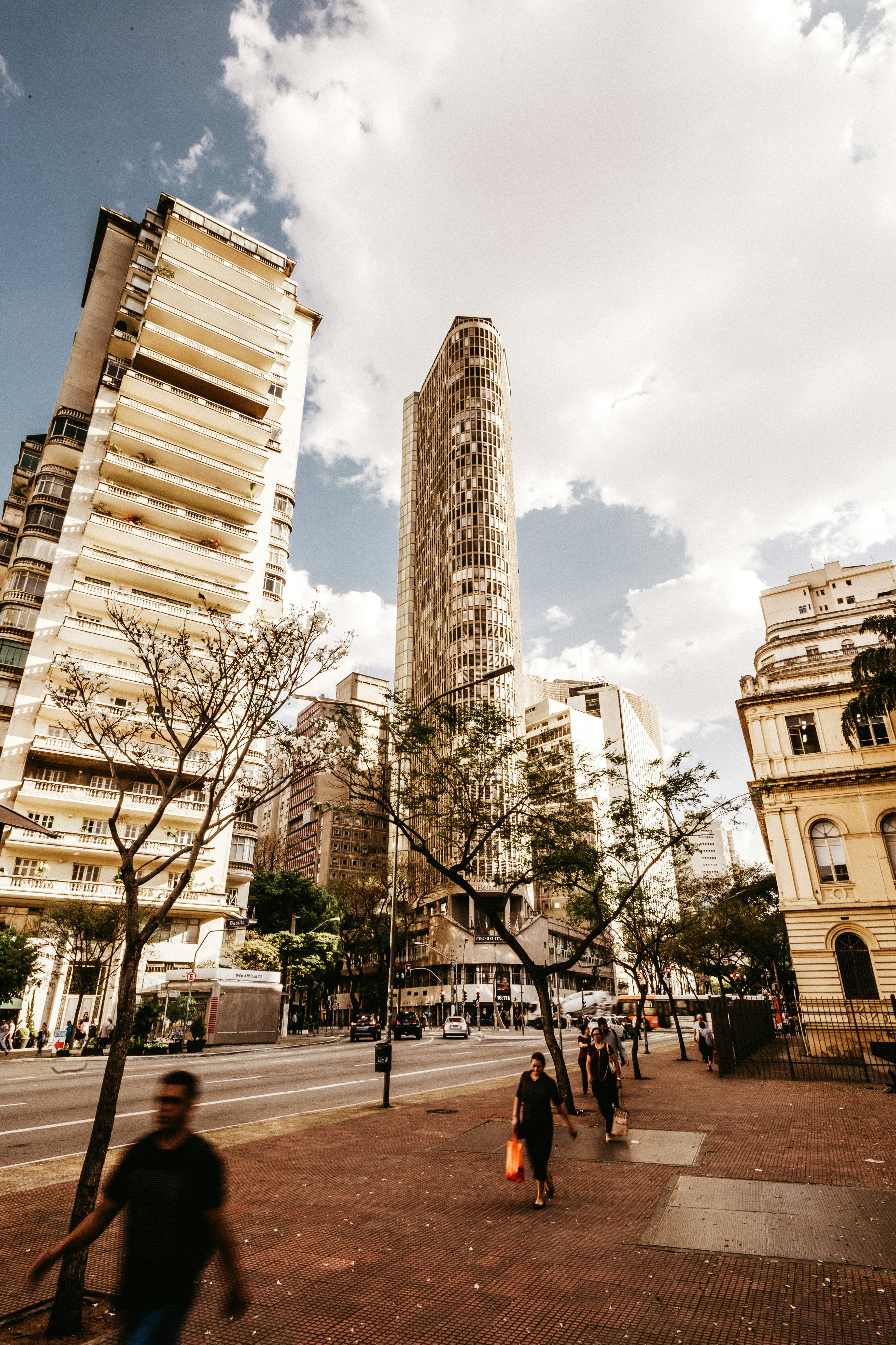 Skyline of Urban Ascent: A City Street Framed by a Glassy Tower