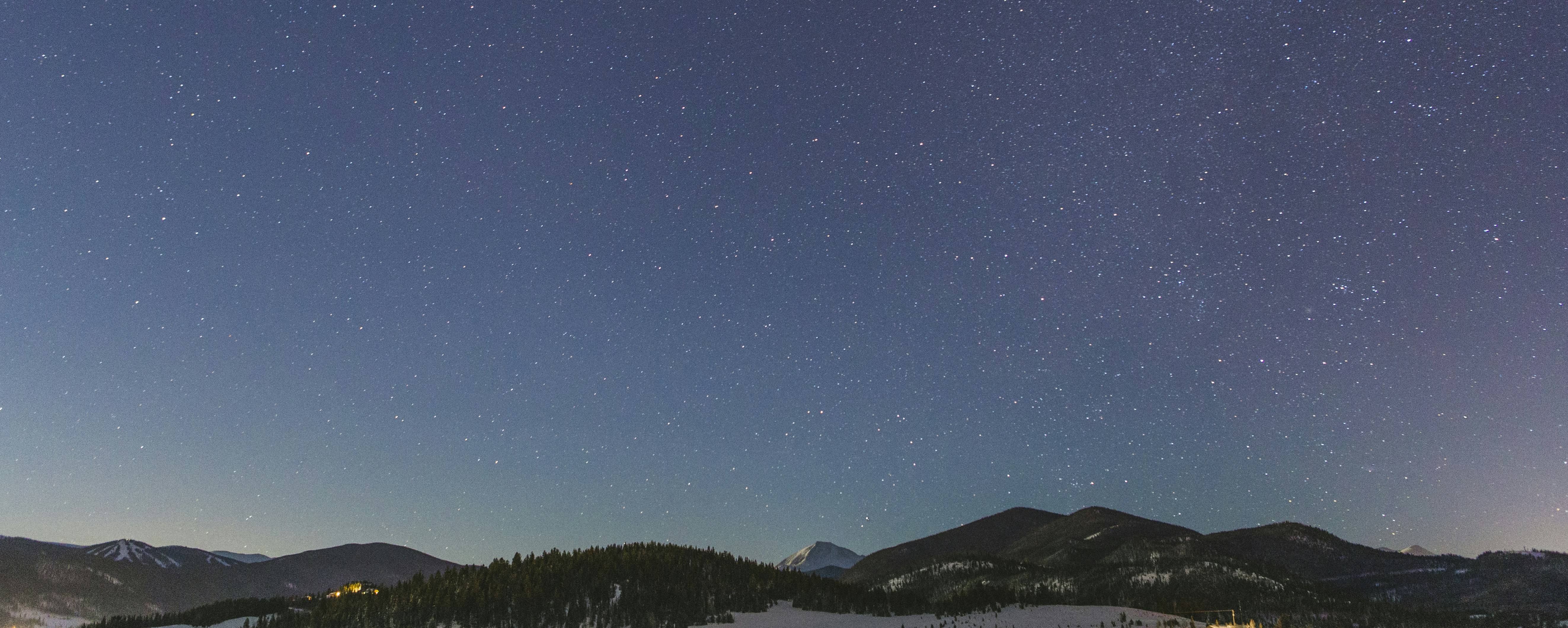 Celestial Harmony Over Mountain Silhouettes