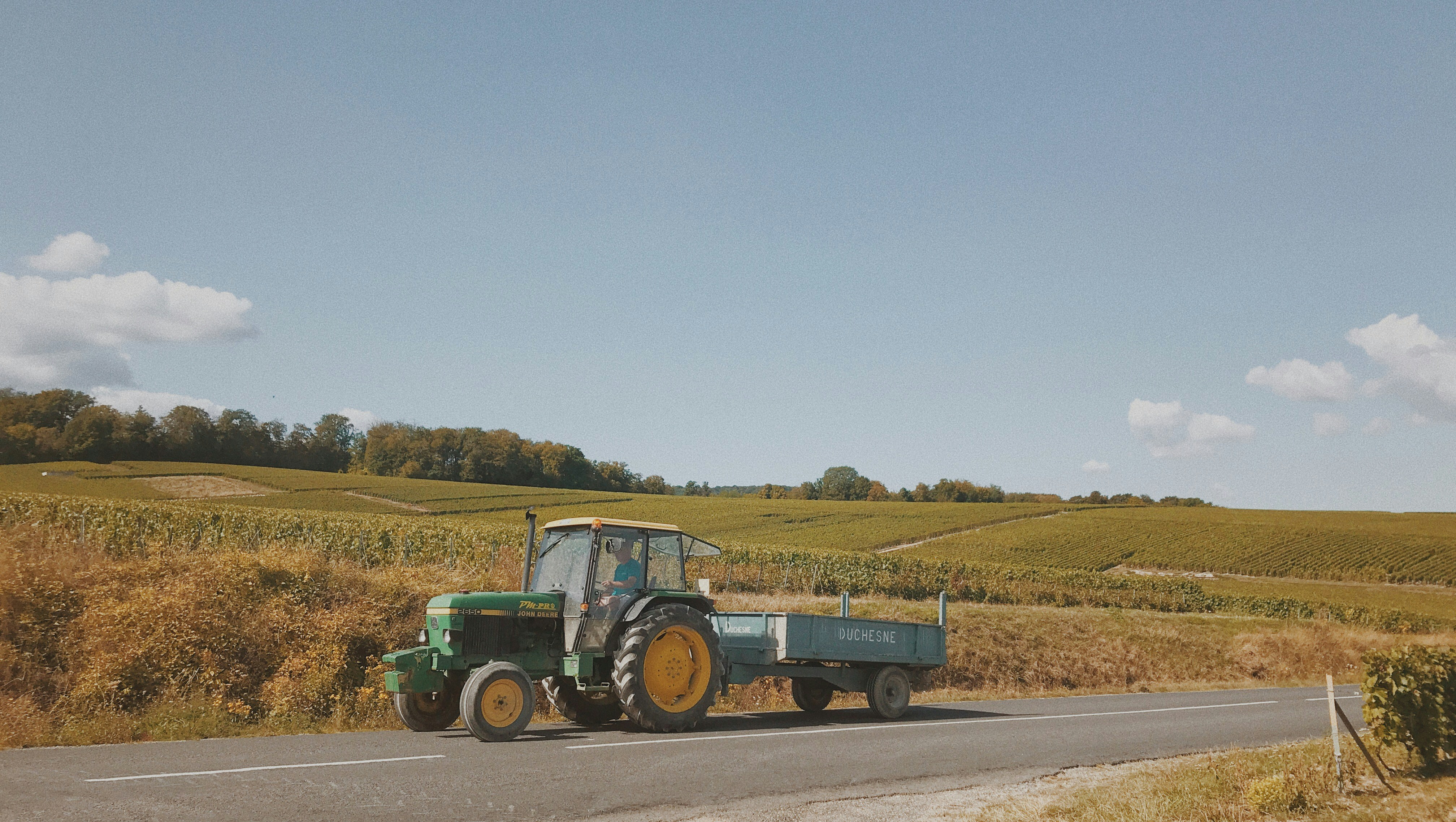 Green and gray farm tractor on concrete road photo – Free Grey Image on ...