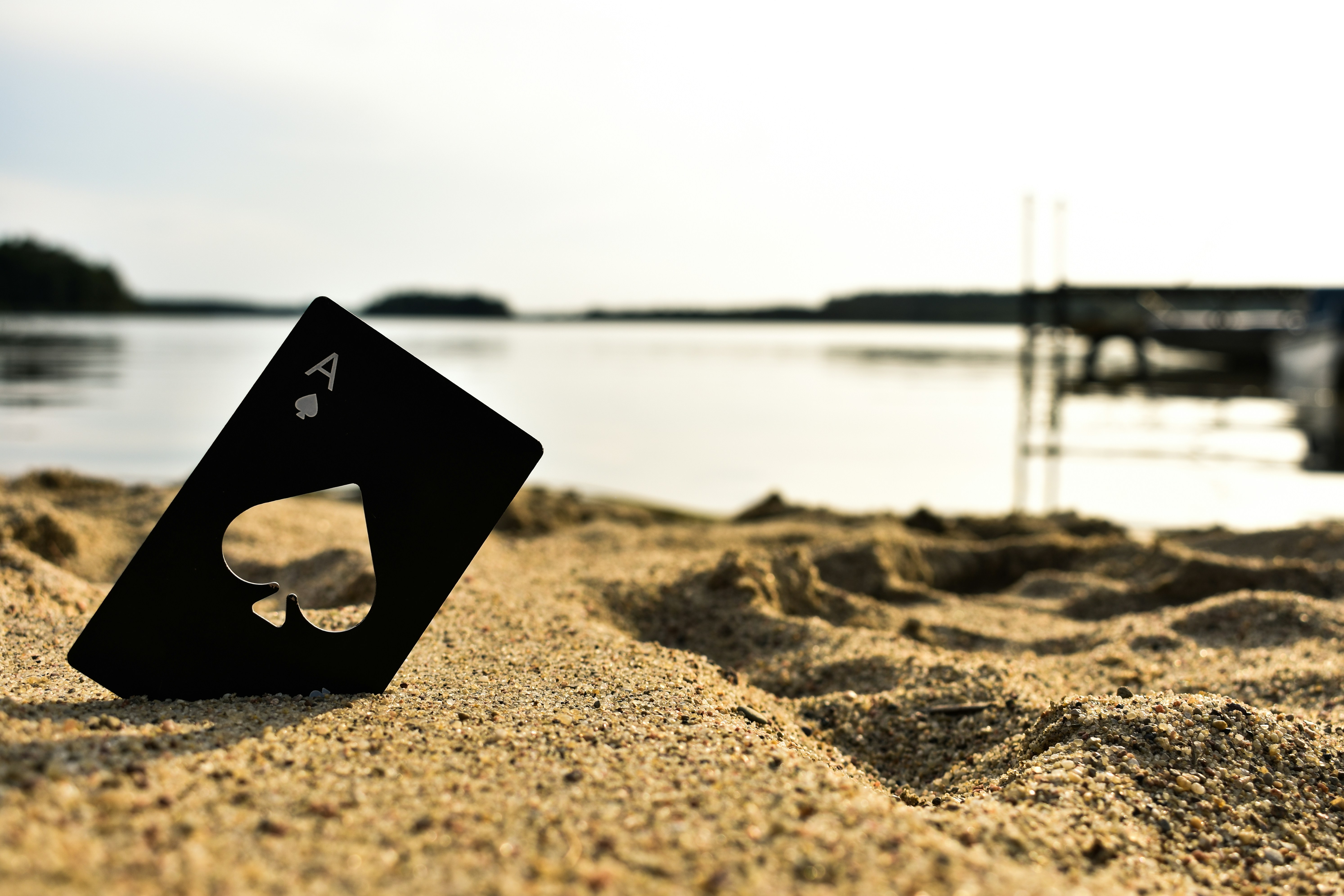 Black ace of spades playing card on sand photo – Free Sand Image on ...