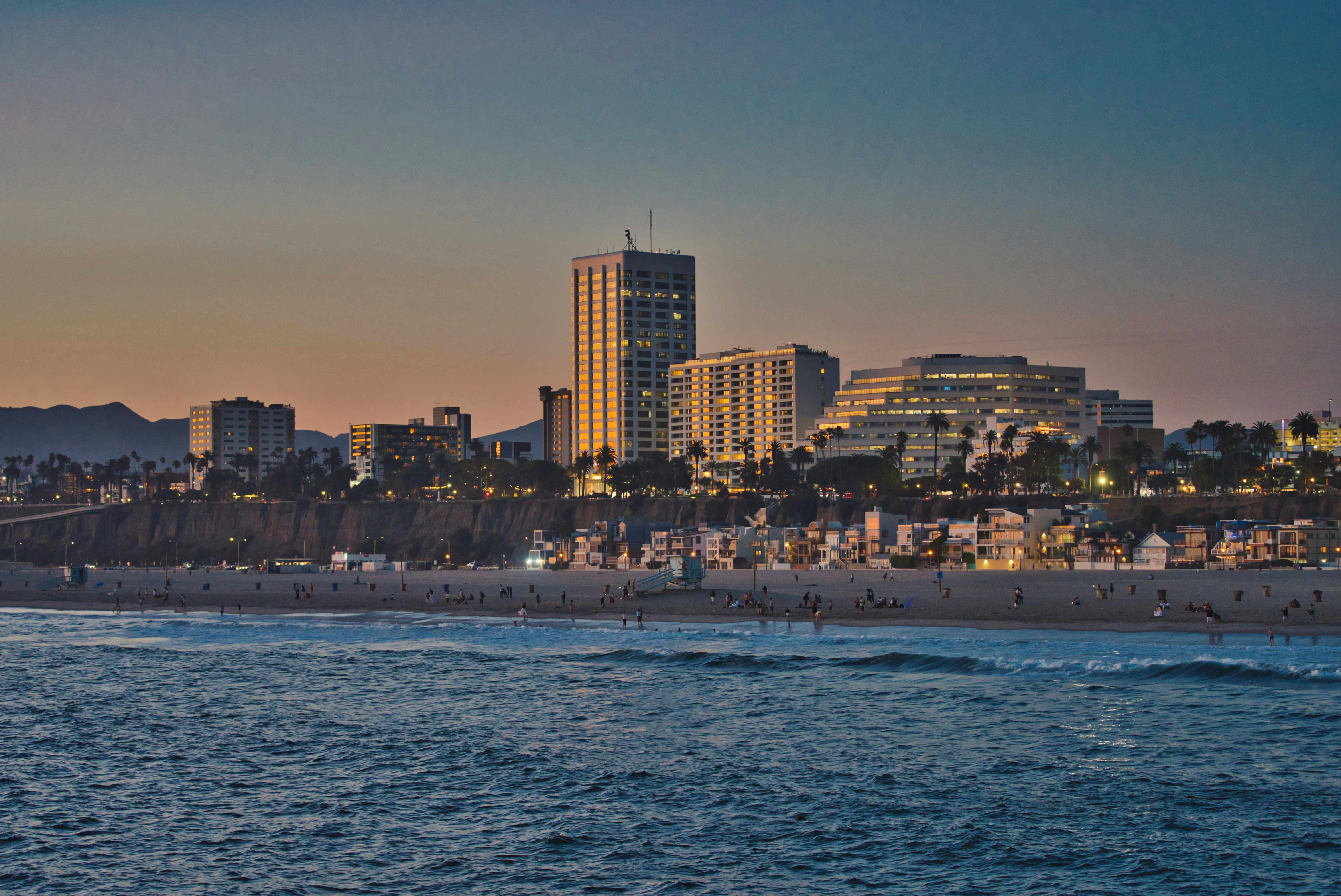 city with high-rise buildings viewing blue sea during daytimeDoctor Tinieblas