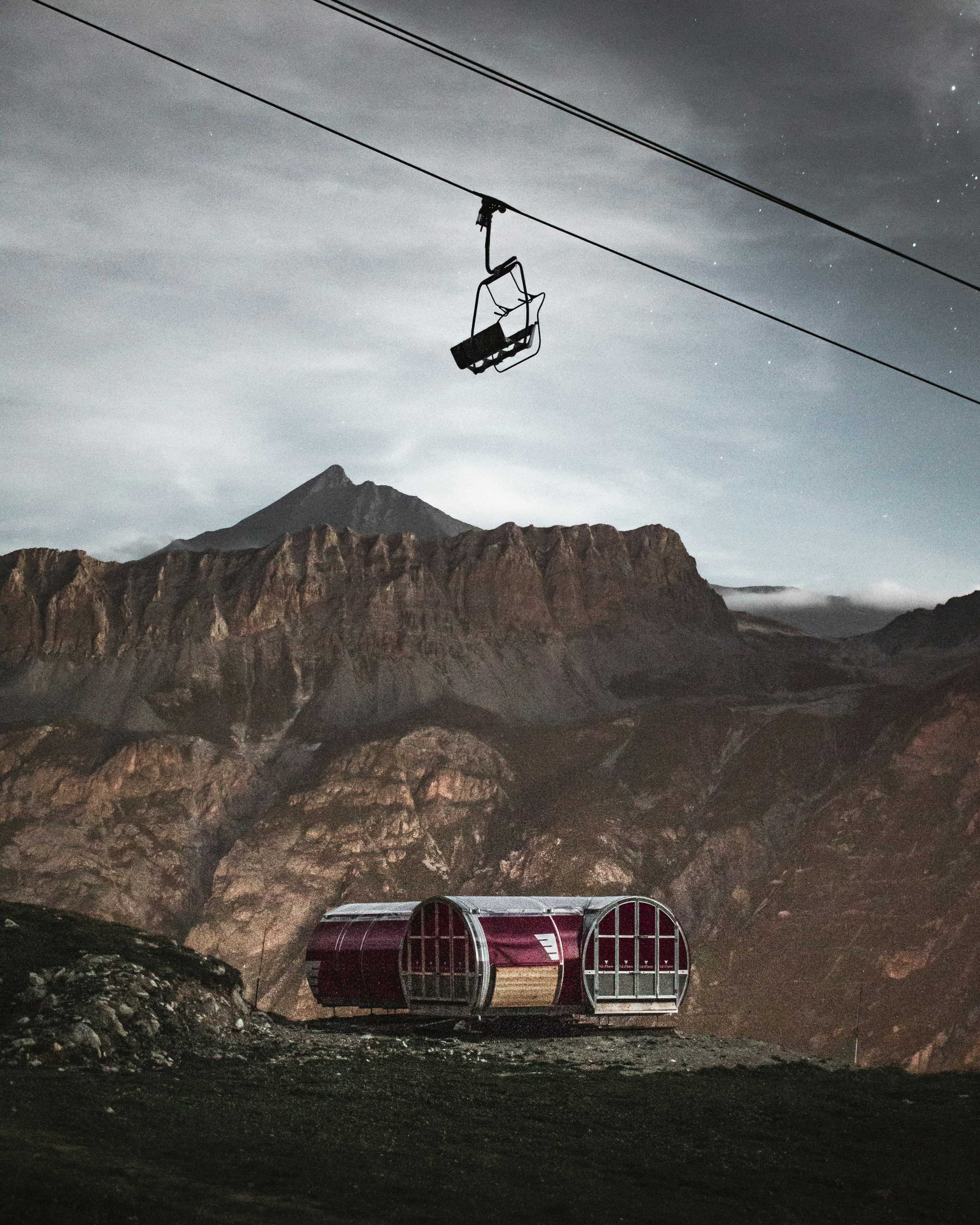 Ridgeline Reverie: A Chairlift Drifts Over a Stone-Sculpted Range