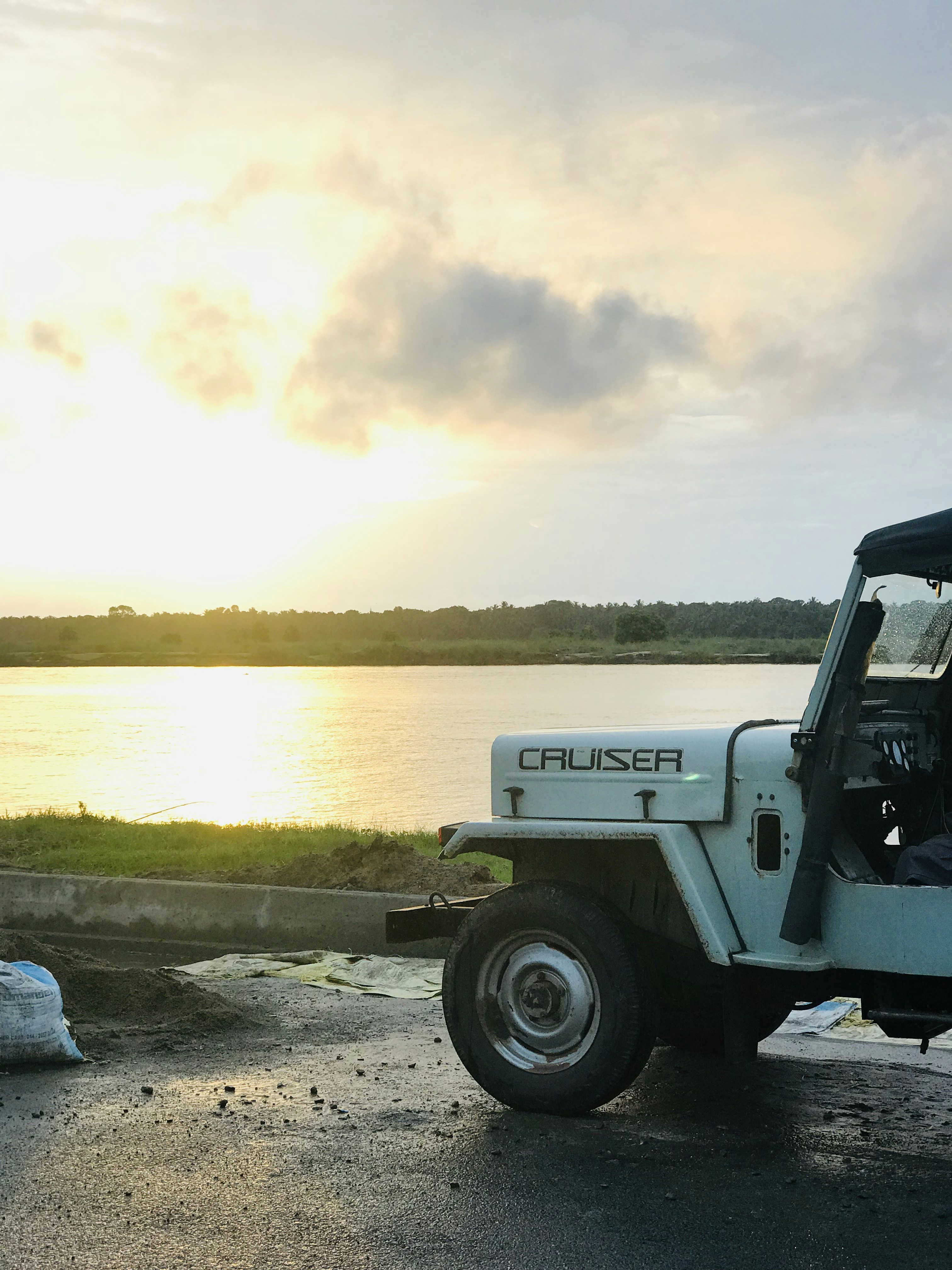 Sunlit Riverside Jeep by the Quiet Shore