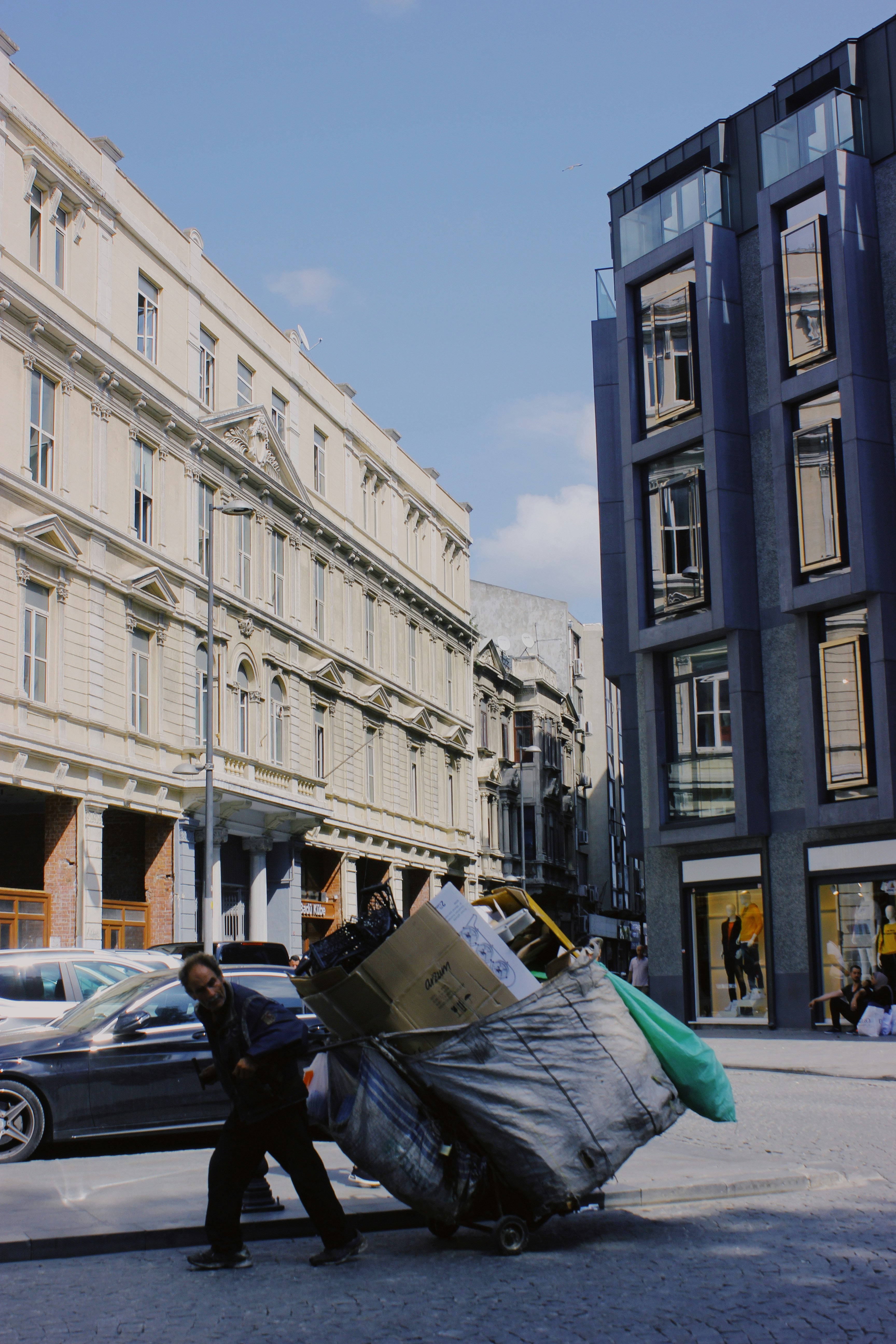 City Gravity: Pushing a Mountain of Trash Through a Sunlit Street
