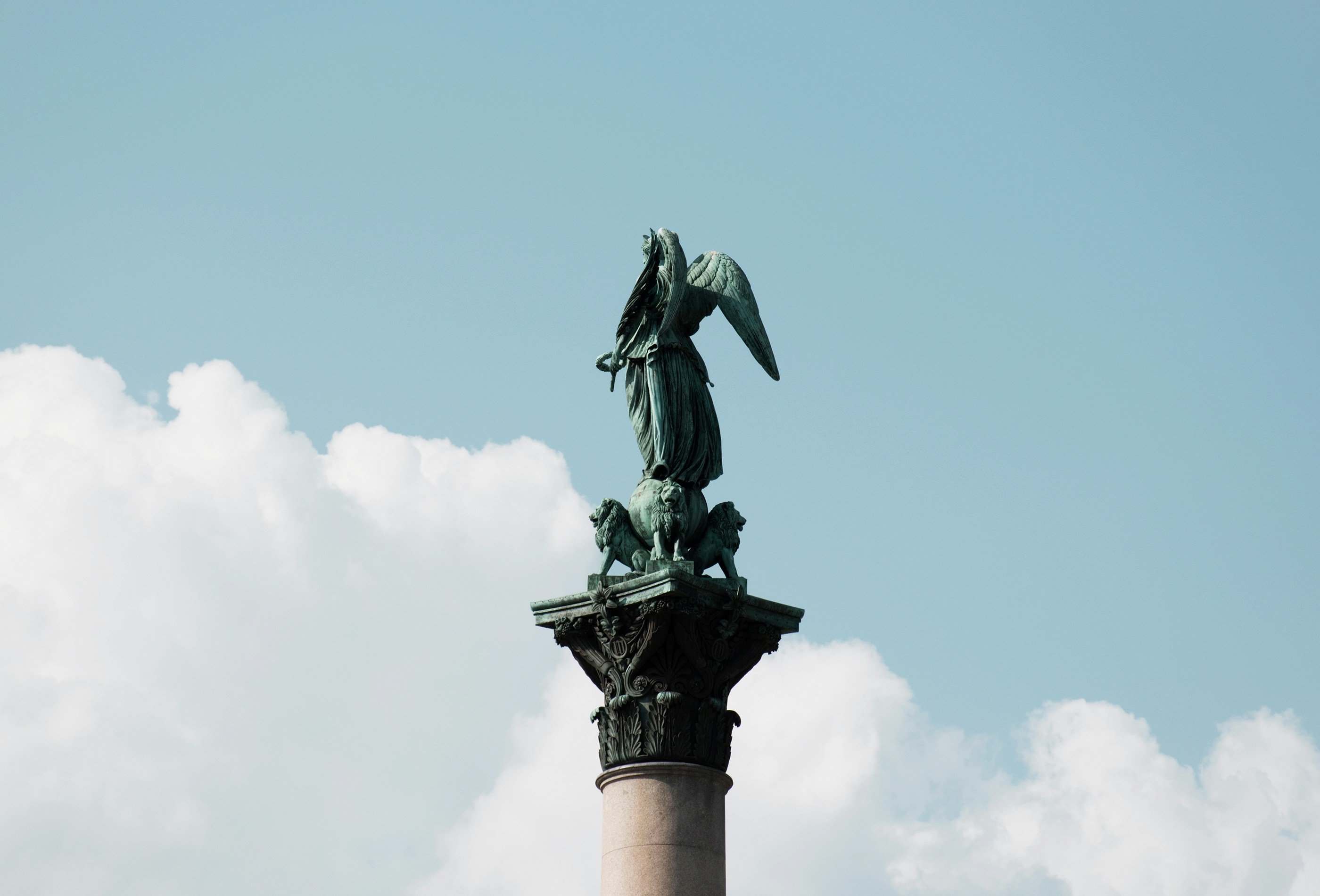 Gray winged statue across blue sky and clouds photo – Free Statue Image ...