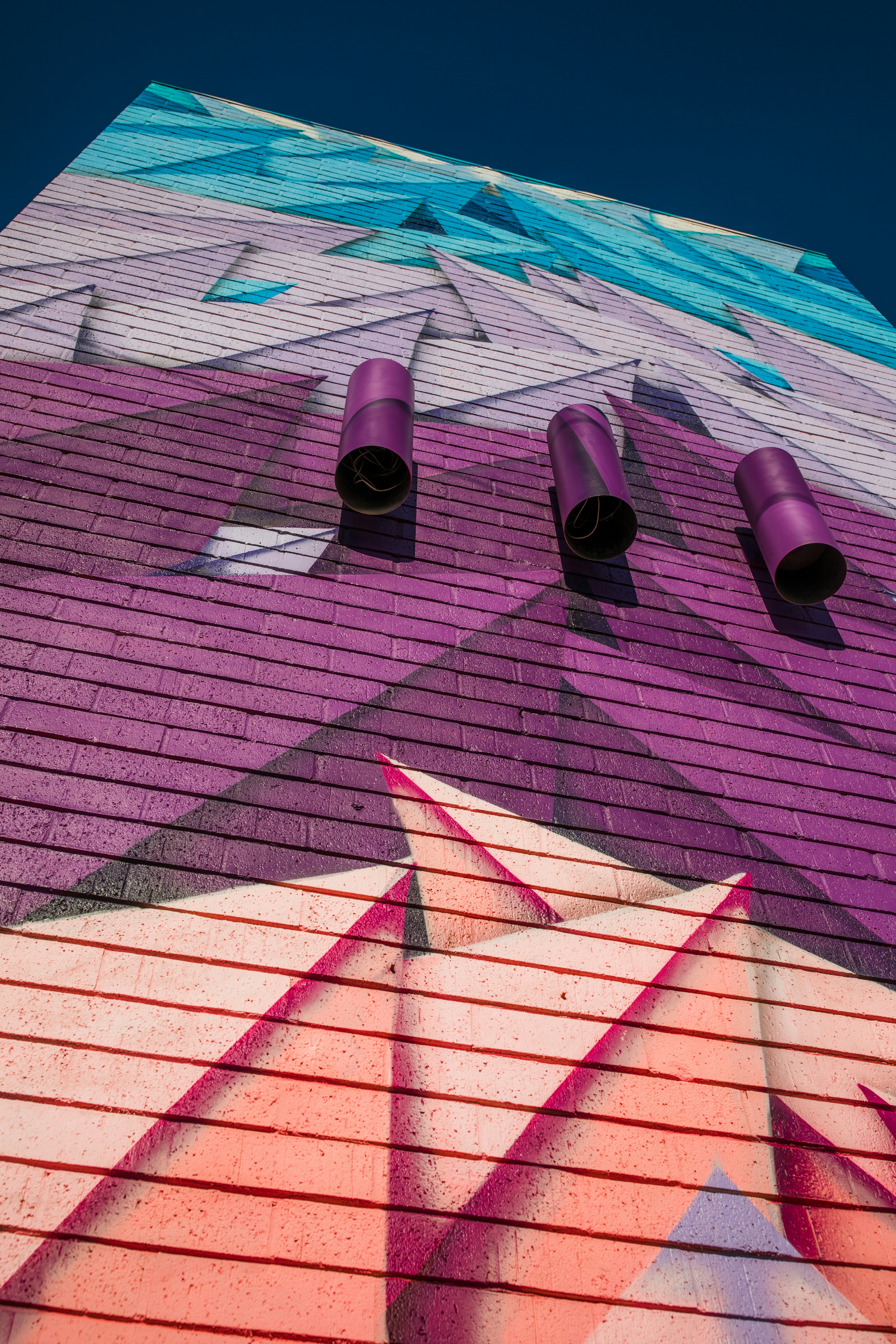 Urban Mosaic: A Tilted Wall of Color and Pipes