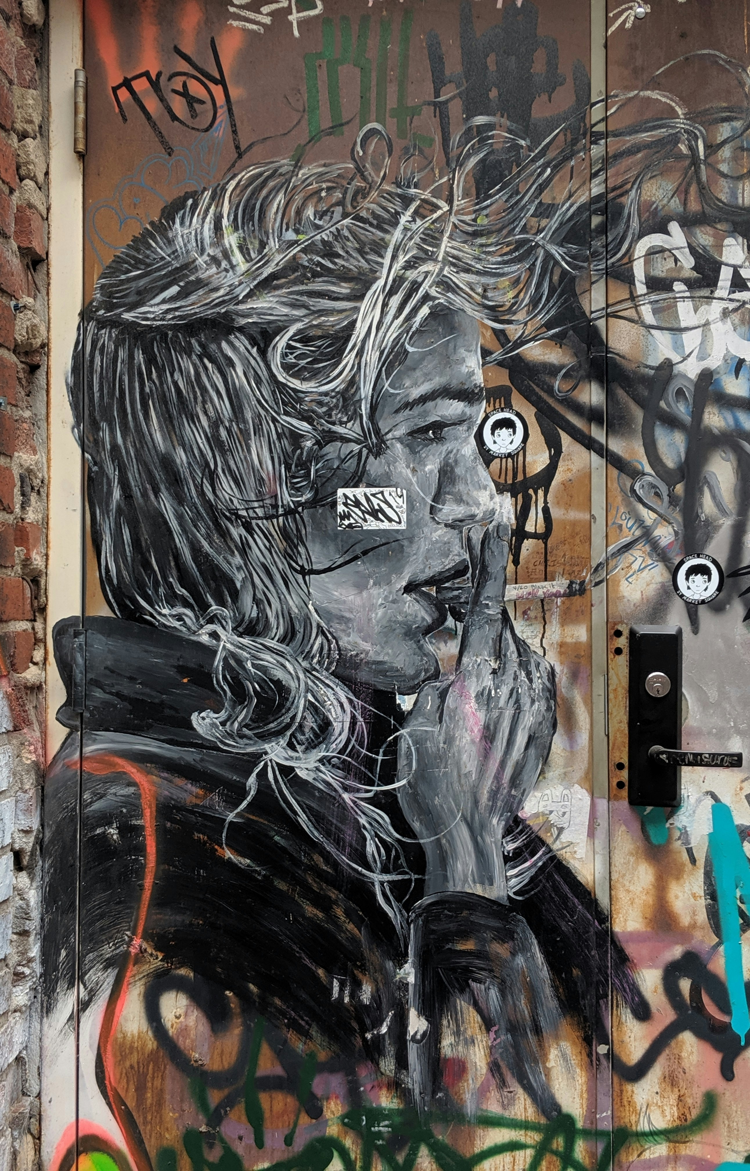 Whispered Graffiti: Portrait on a Doorway of Chalked Steel