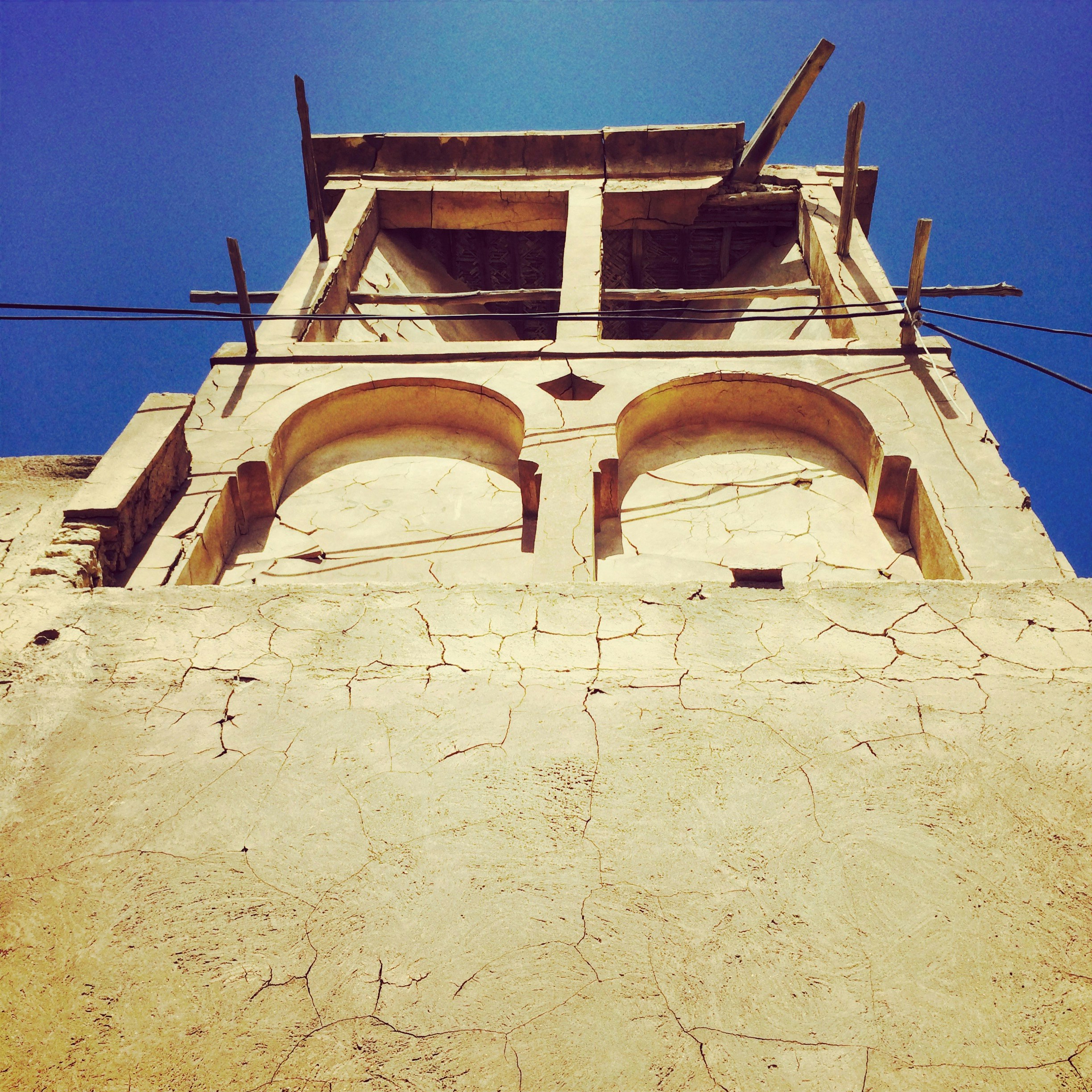 Cracked Facade Under a Watery Sky