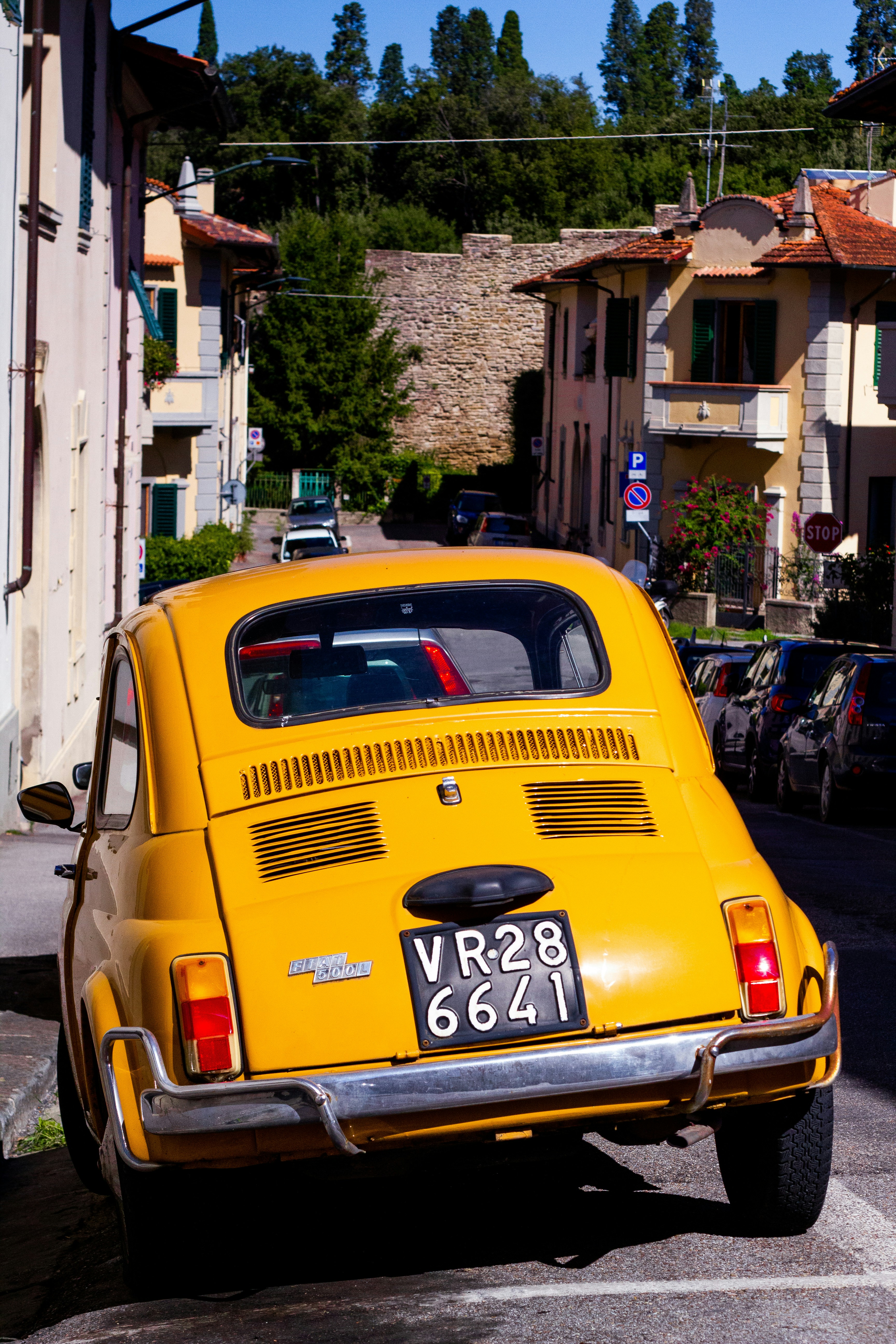 Sunlit Yellow Fiat 500 Backed into a Quiet Italian Street