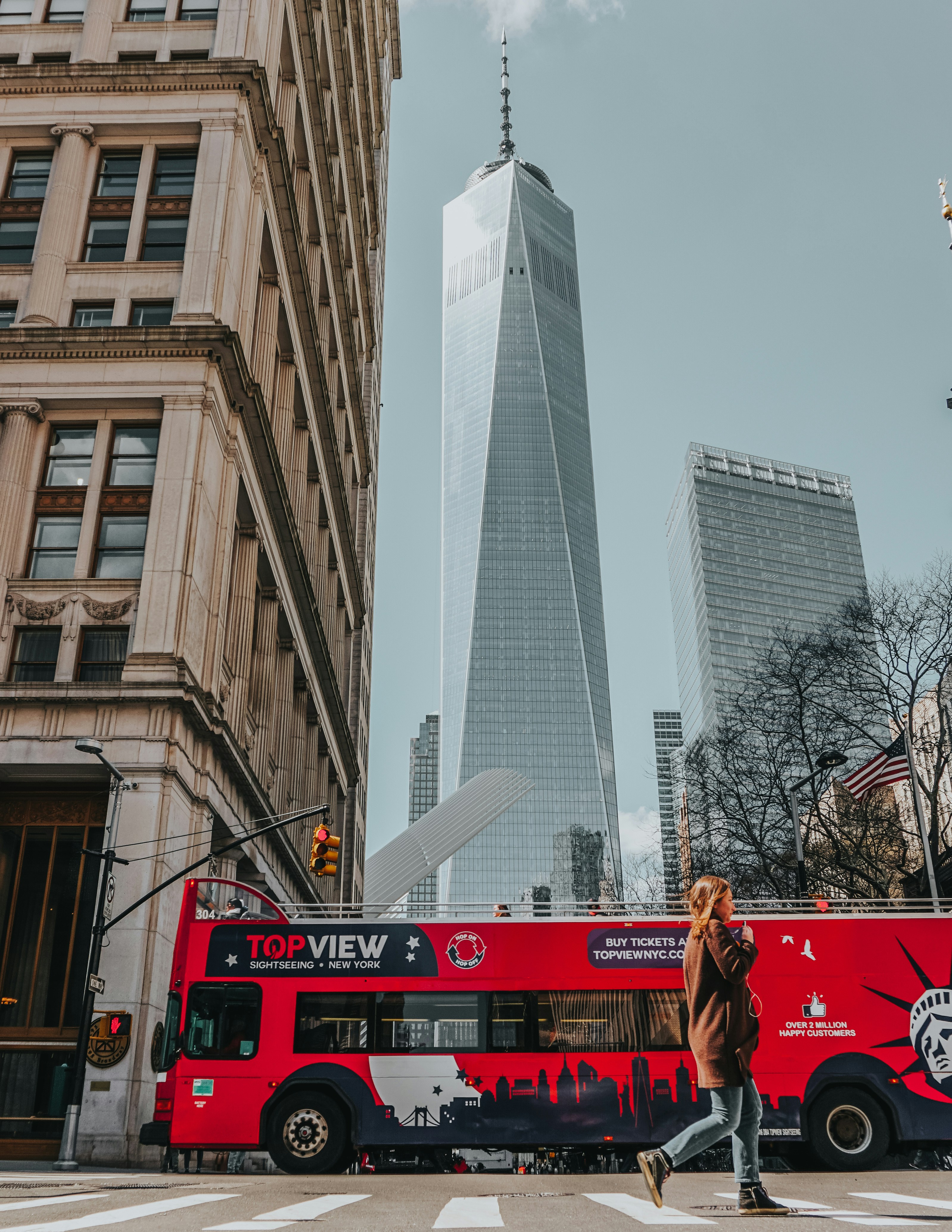 Red Bus at the Foot of a Glass Giant: Lower Manhattan Rising