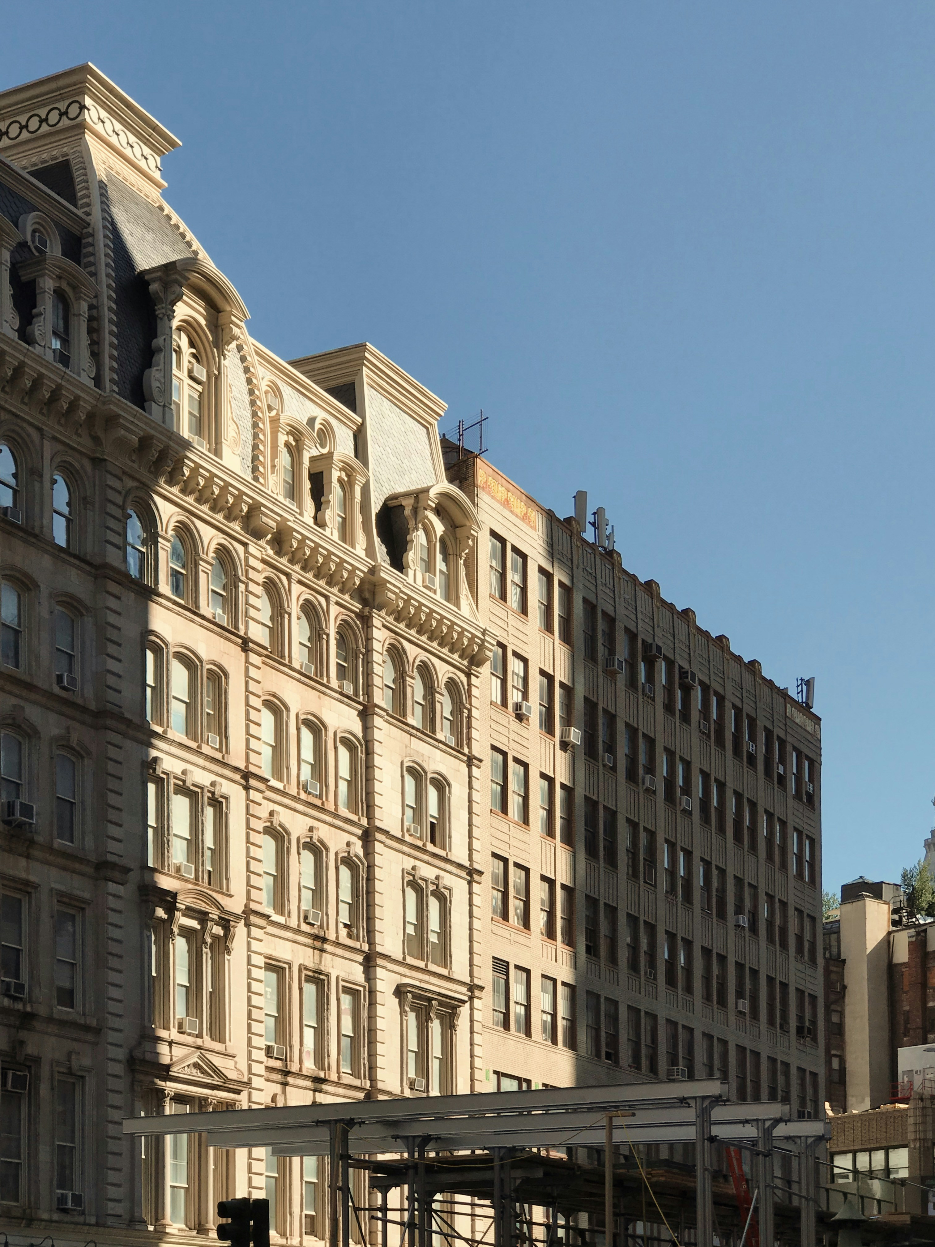 White concrete multi-storey European-styled building under a calm blue ...