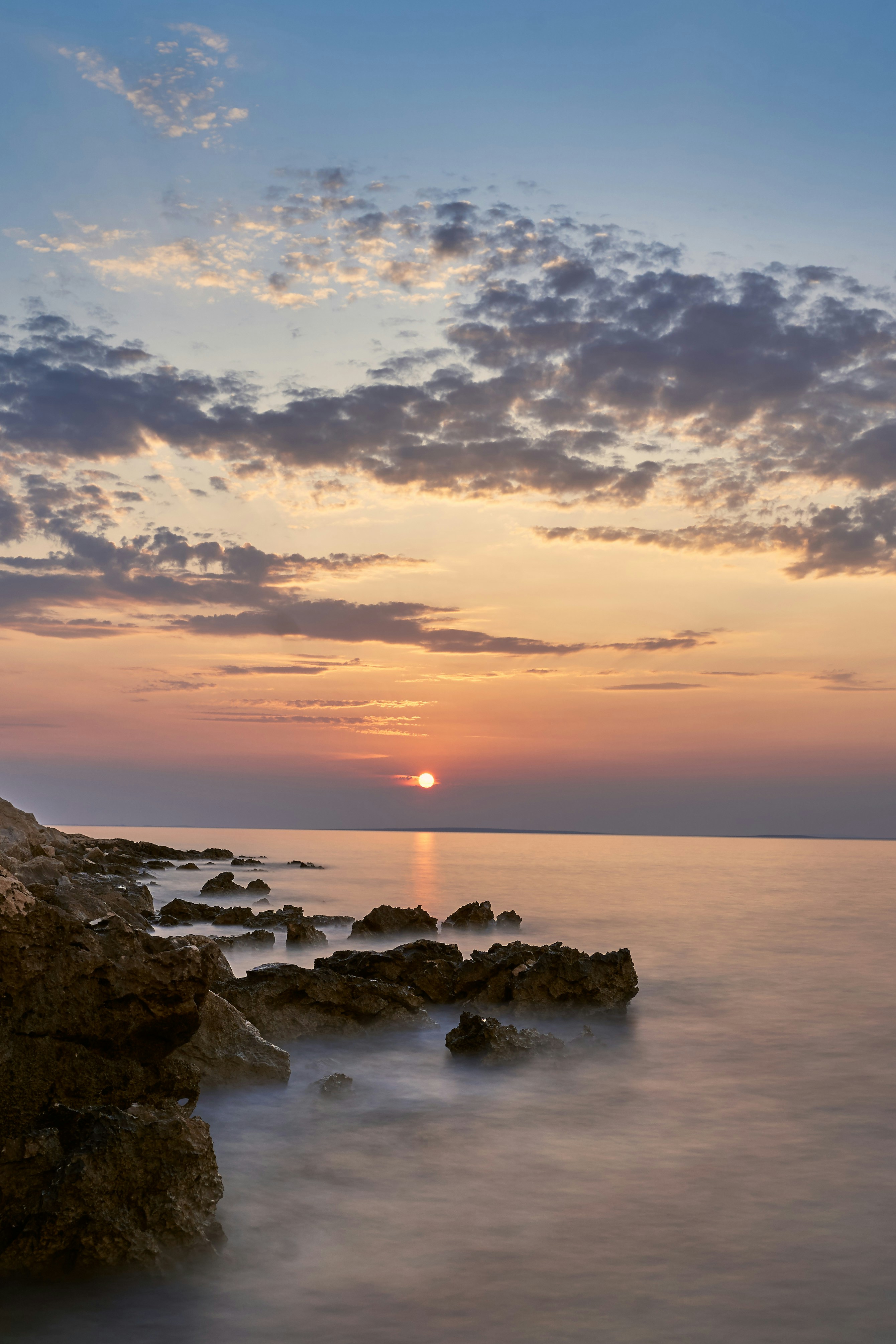 Ember Horizon: Sunset Over Rugged Coastline