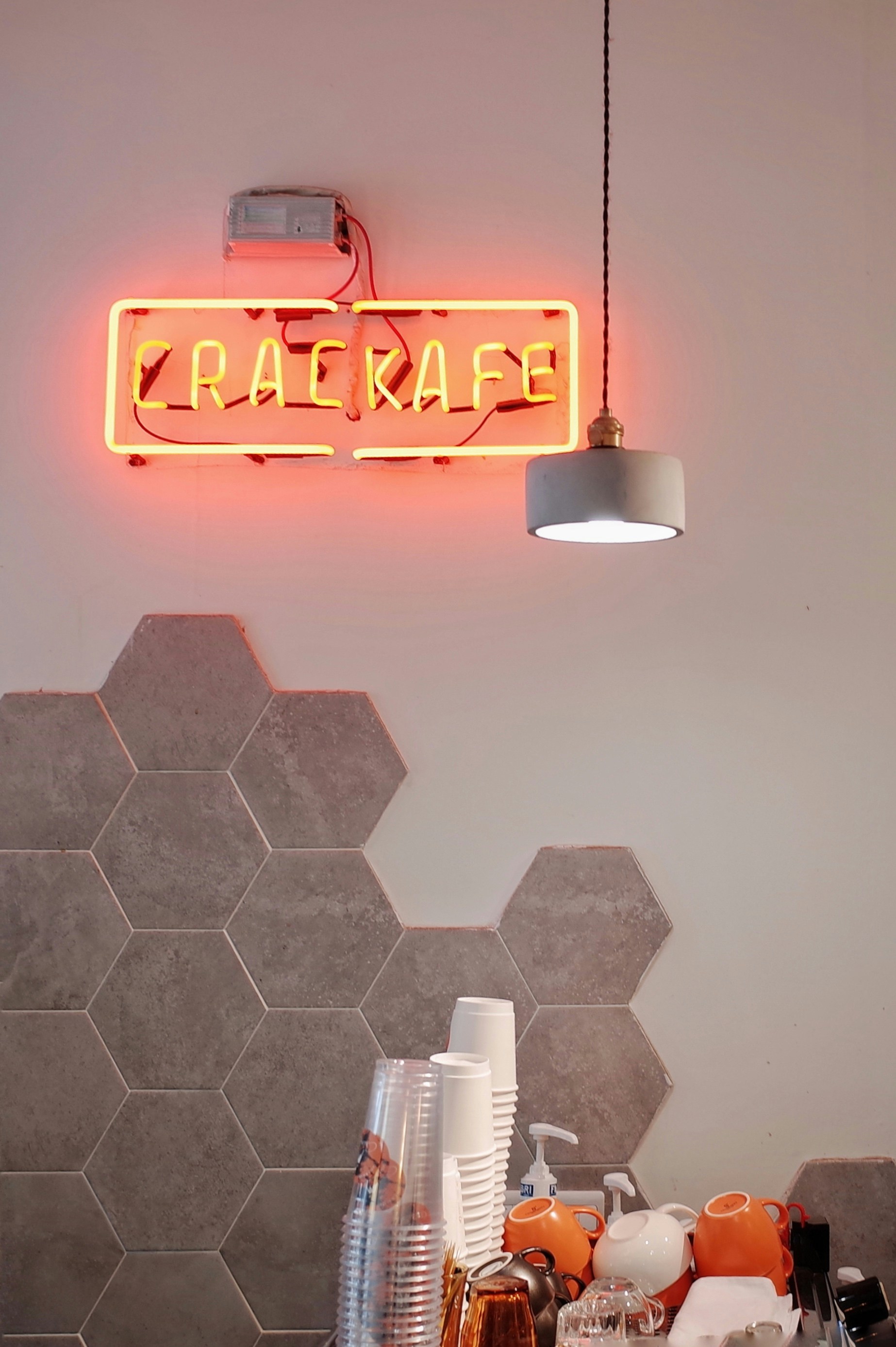 Neon Sign over Hex Tile Mosaic in Cozy Café Corner