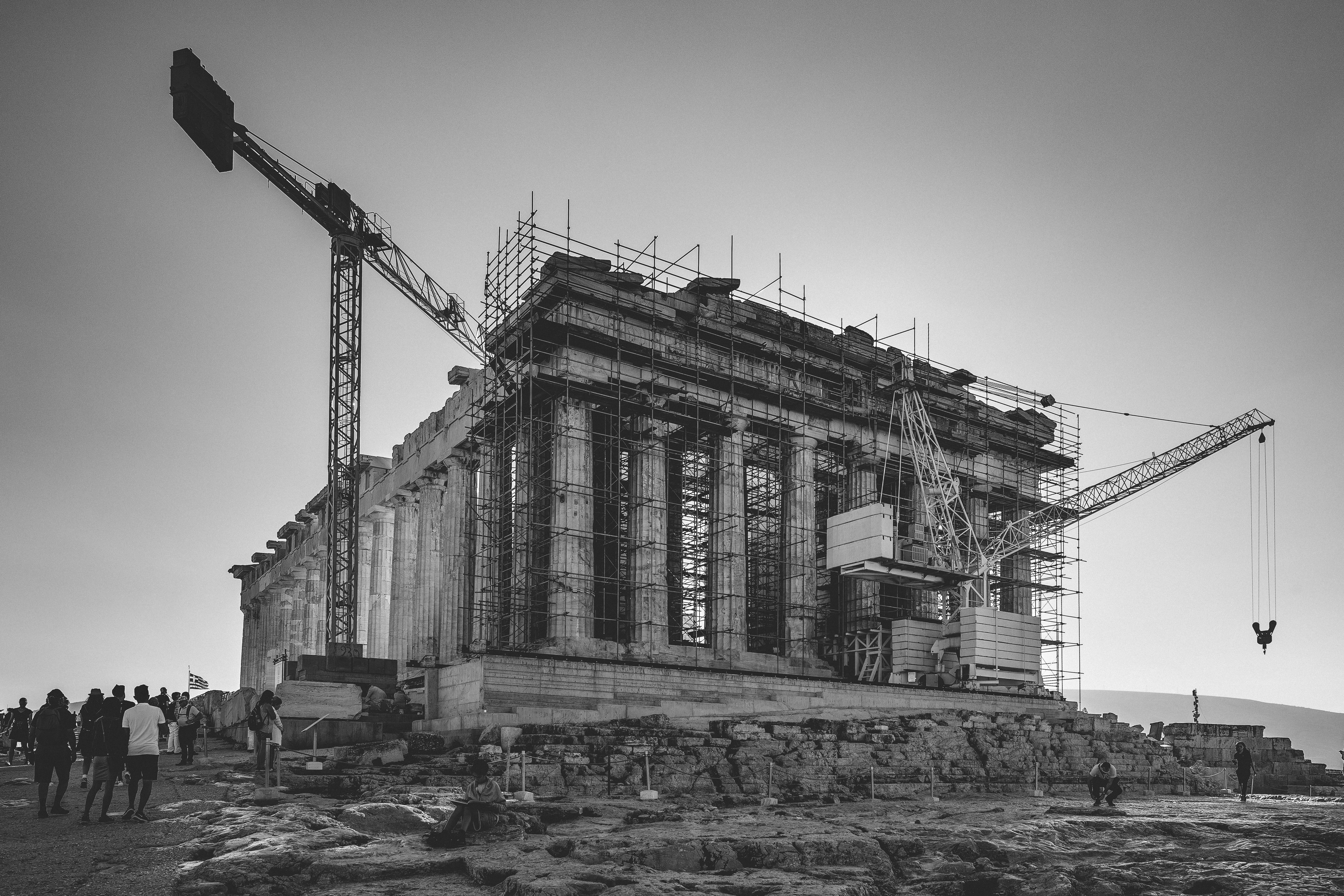 The Parthenon, partially obscured by scaffolding and construction equipment, stands as a testament to ancient architecture amidst ongoing restoration efforts.