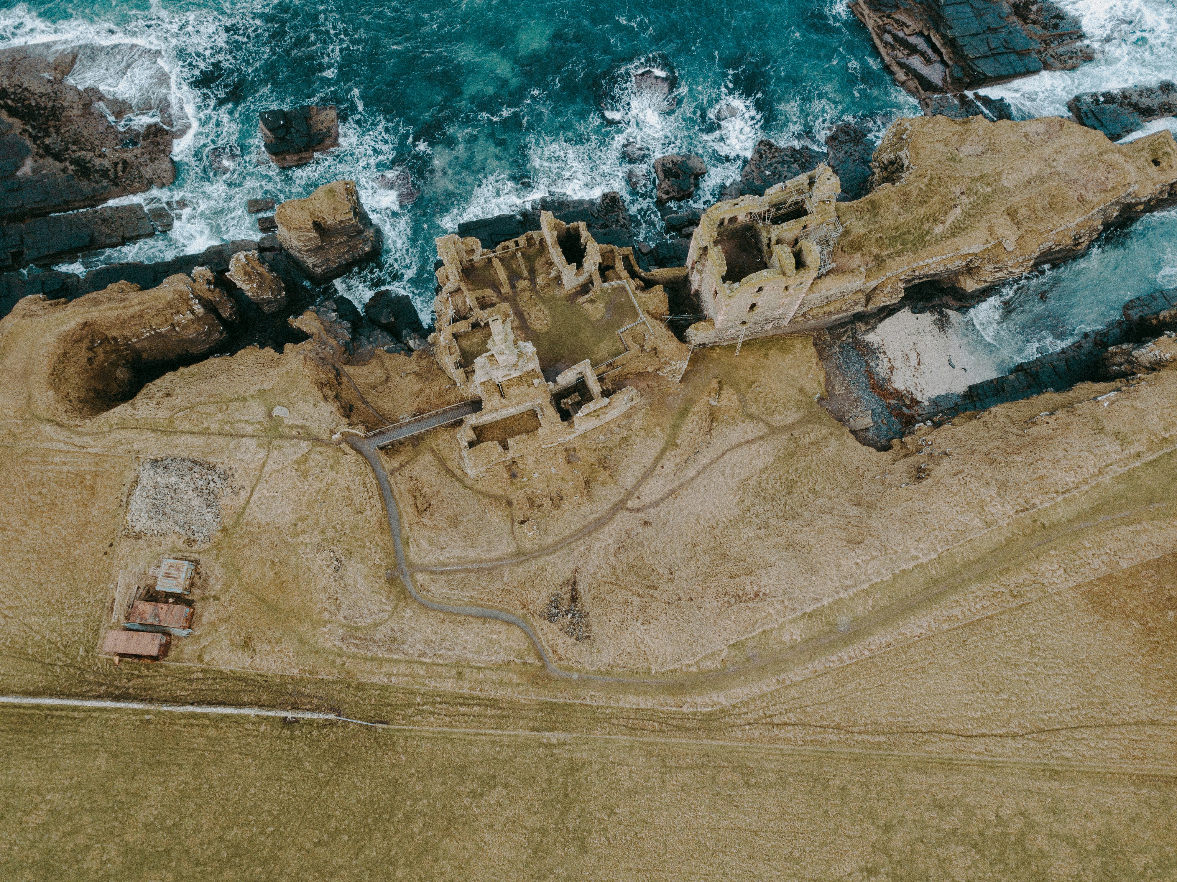Ruins by the Sea: Aerial Pathways Through Weathered Cliffs
