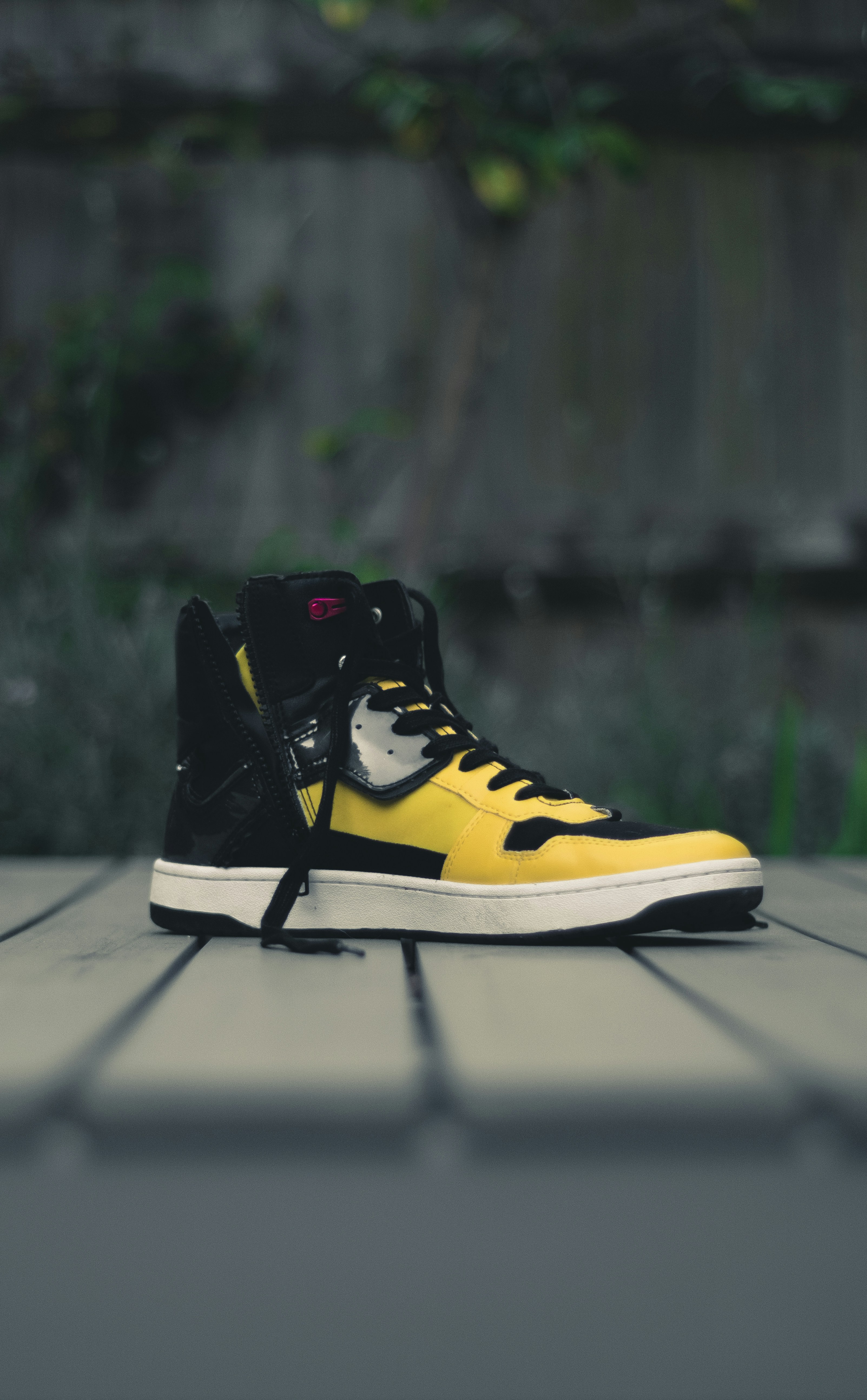 Yellow-Black Sneaker on a Weathered Deck