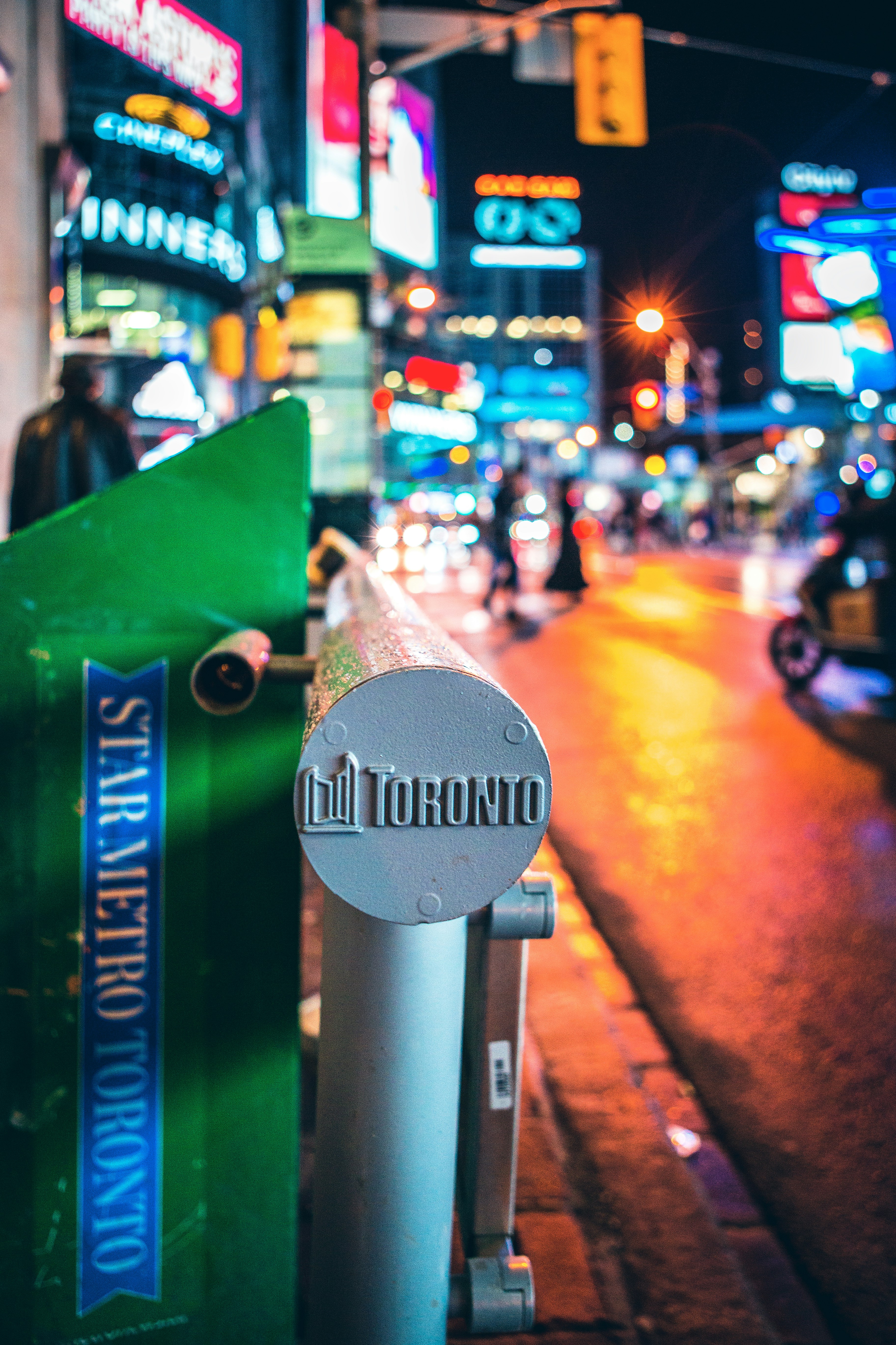 Circular Toronto Emblem Anchored in a Neon Night Street