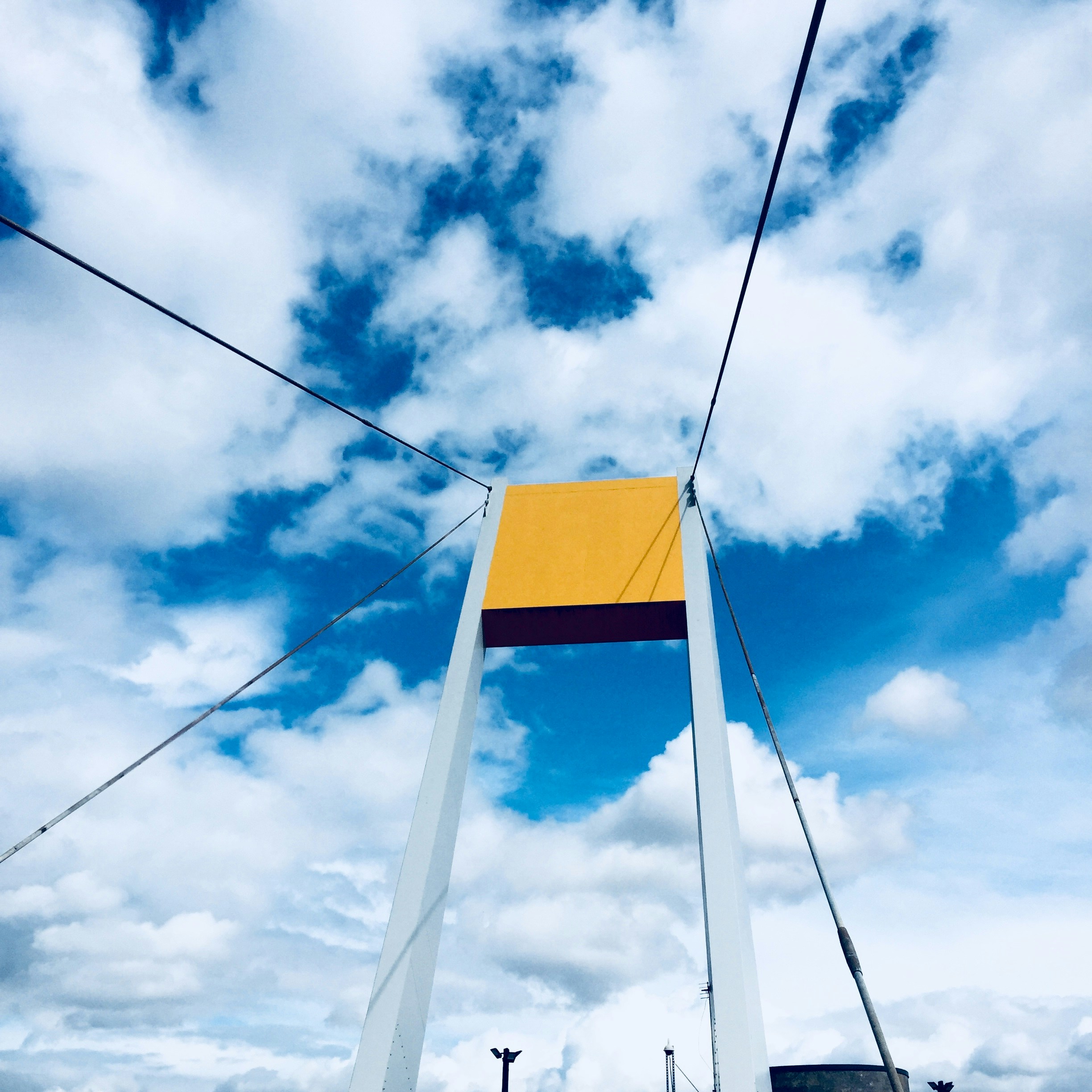 Skyward Crown: The Yellow Cap of a Suspension Bridge