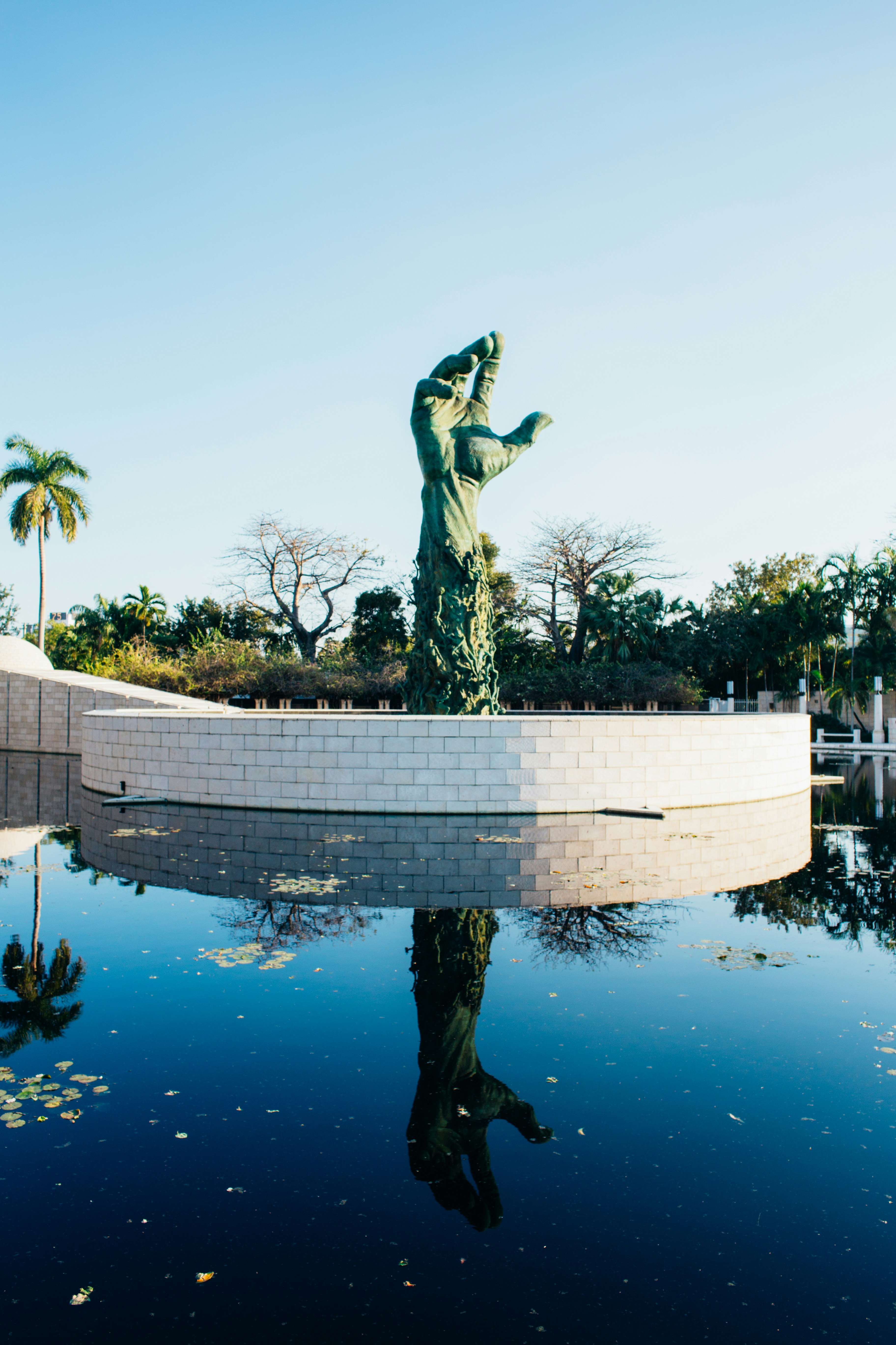 Human hand concrete statue near body of water photo – Free Miami Image ...