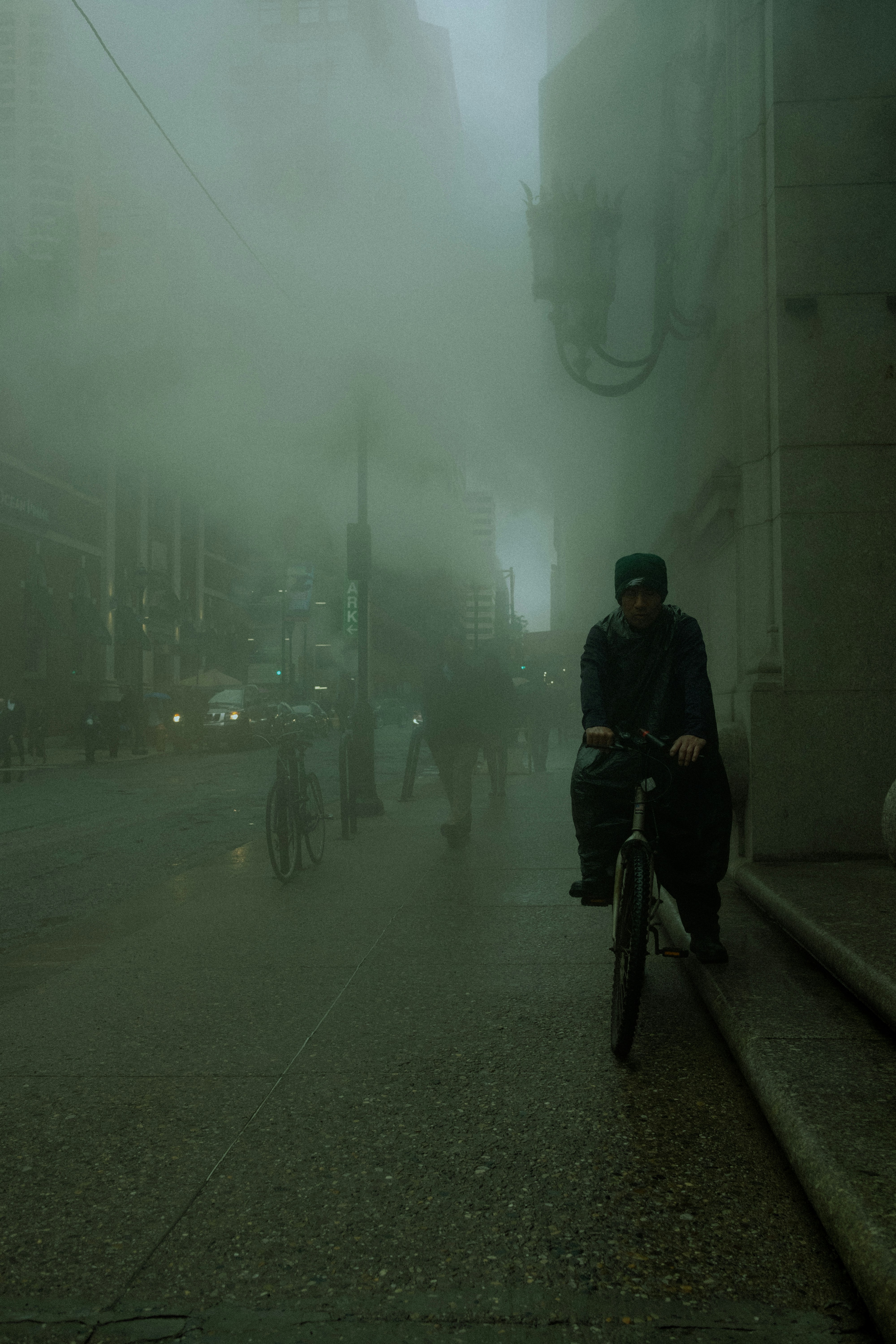 Fogbound Cyclist on a Vaporous City Street