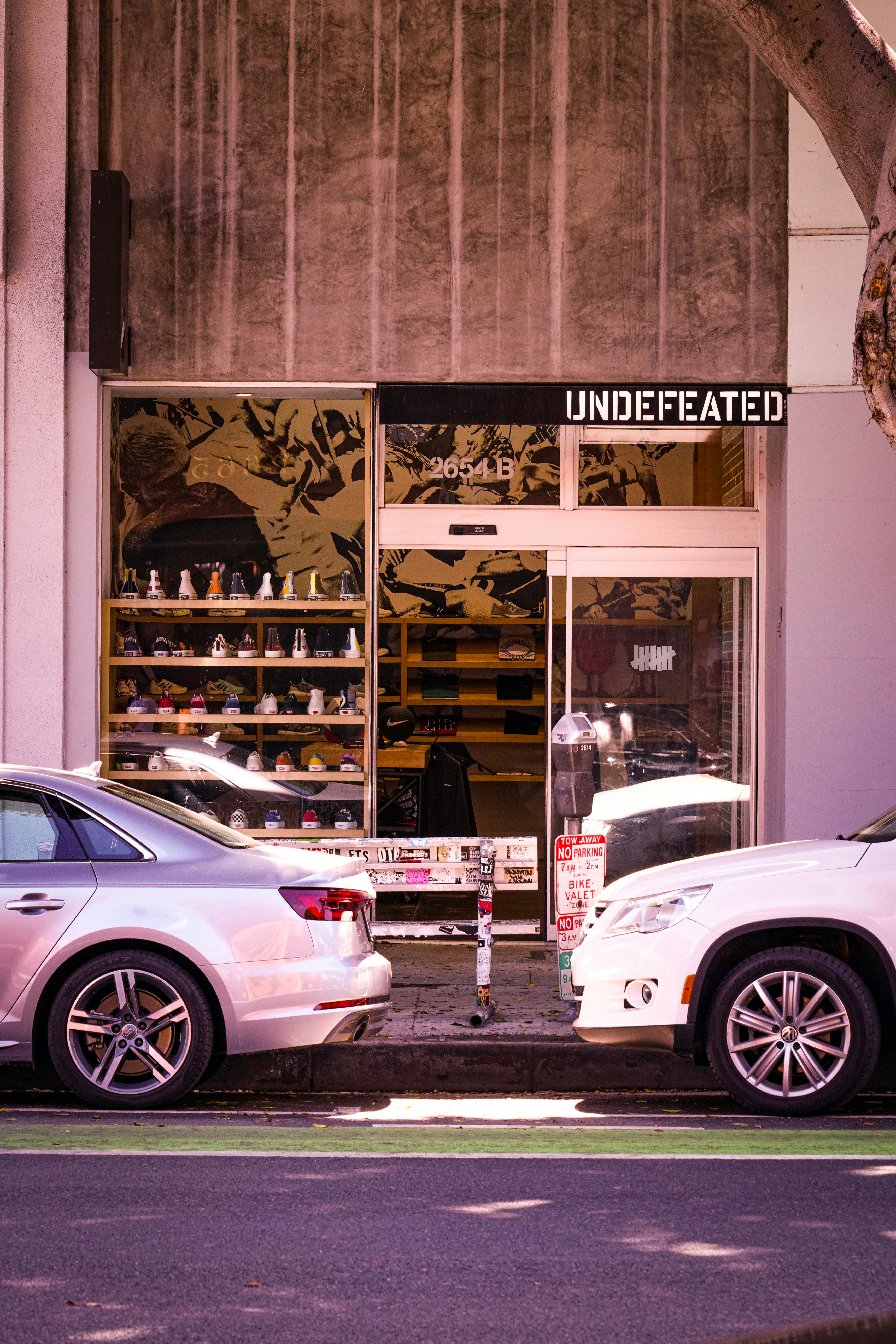 Shopfront Shoes: Urban Window Display Between Parked Cars