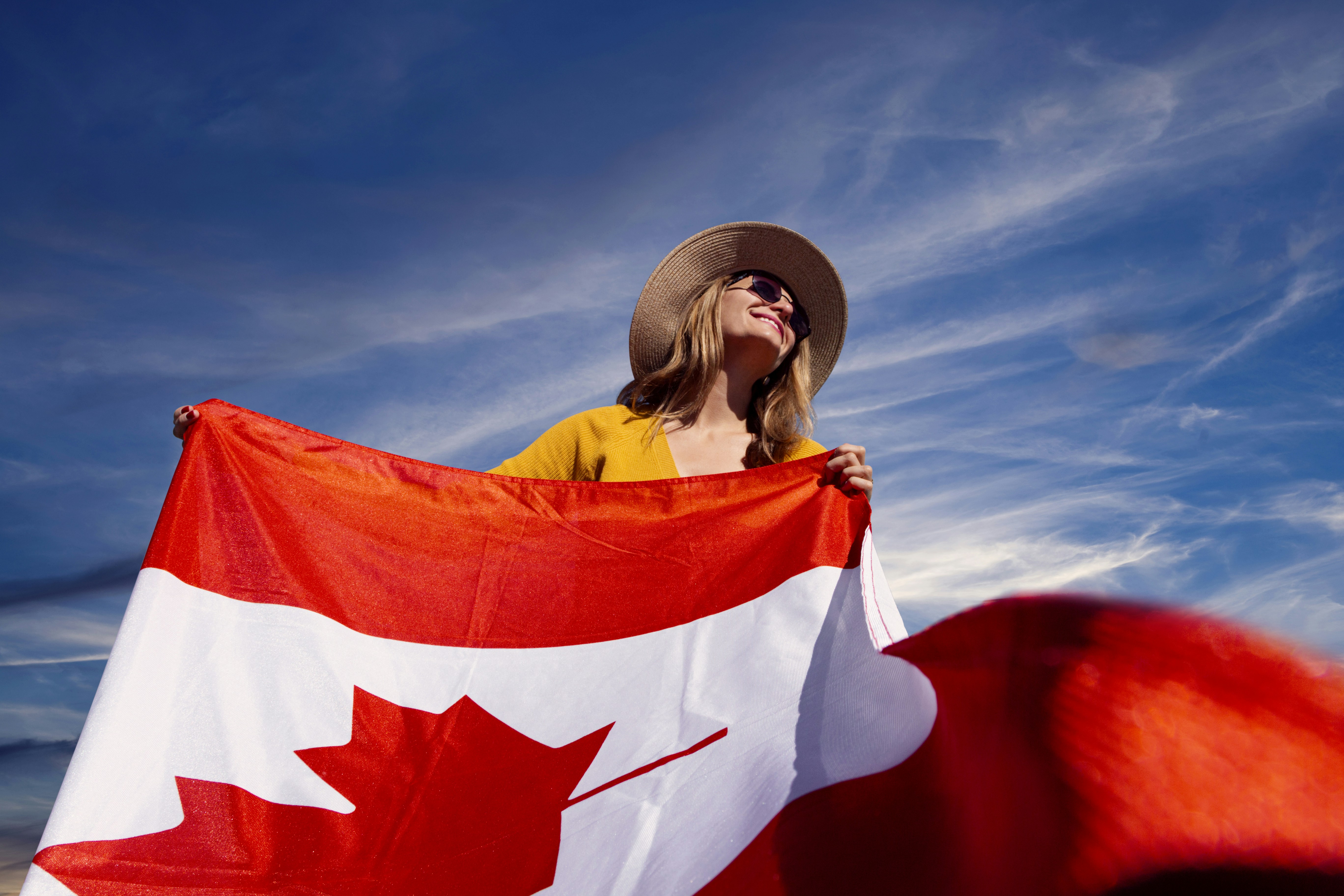 woman holding flag of Canada