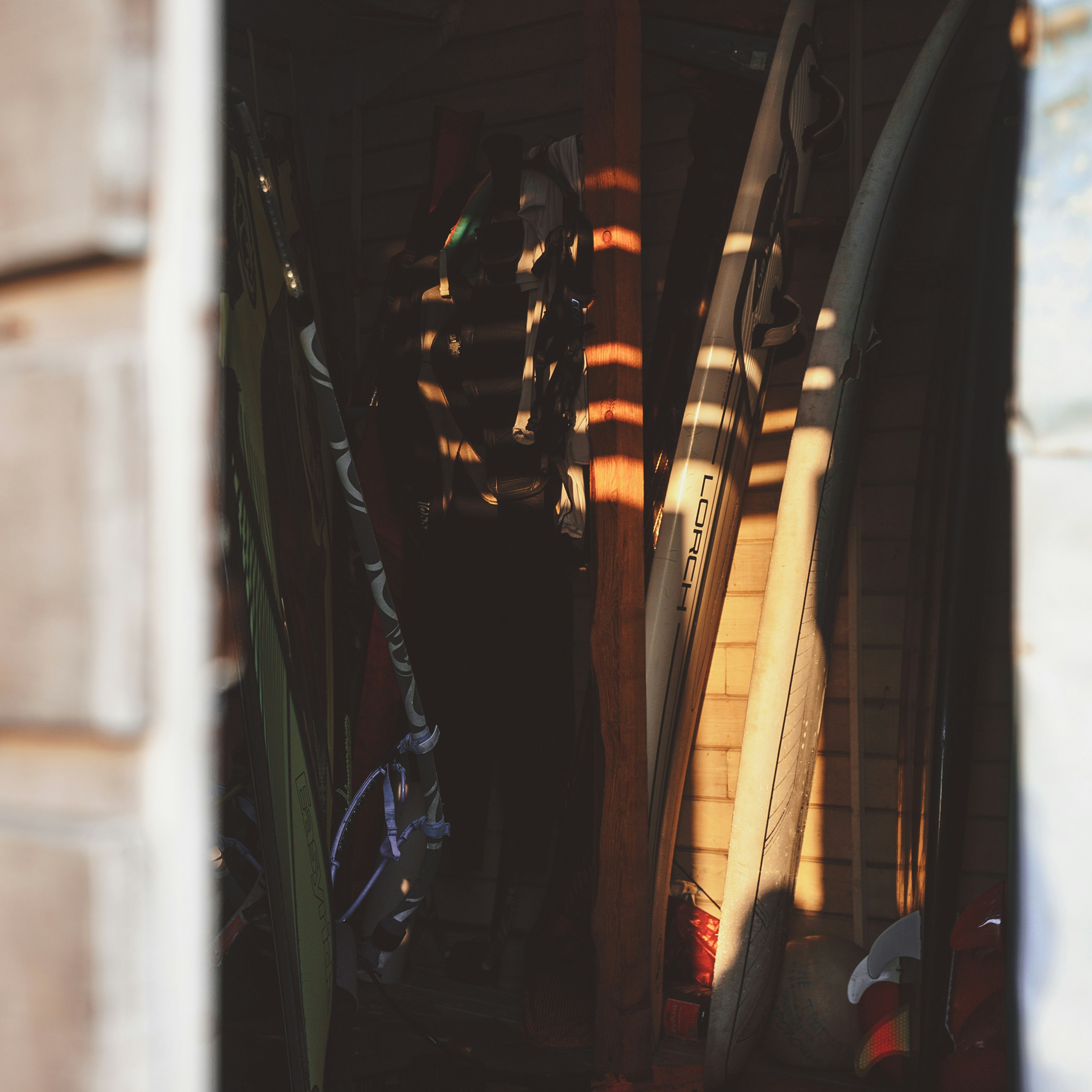 Dappled Light on Surfboards: A Quiet Shed Still Life