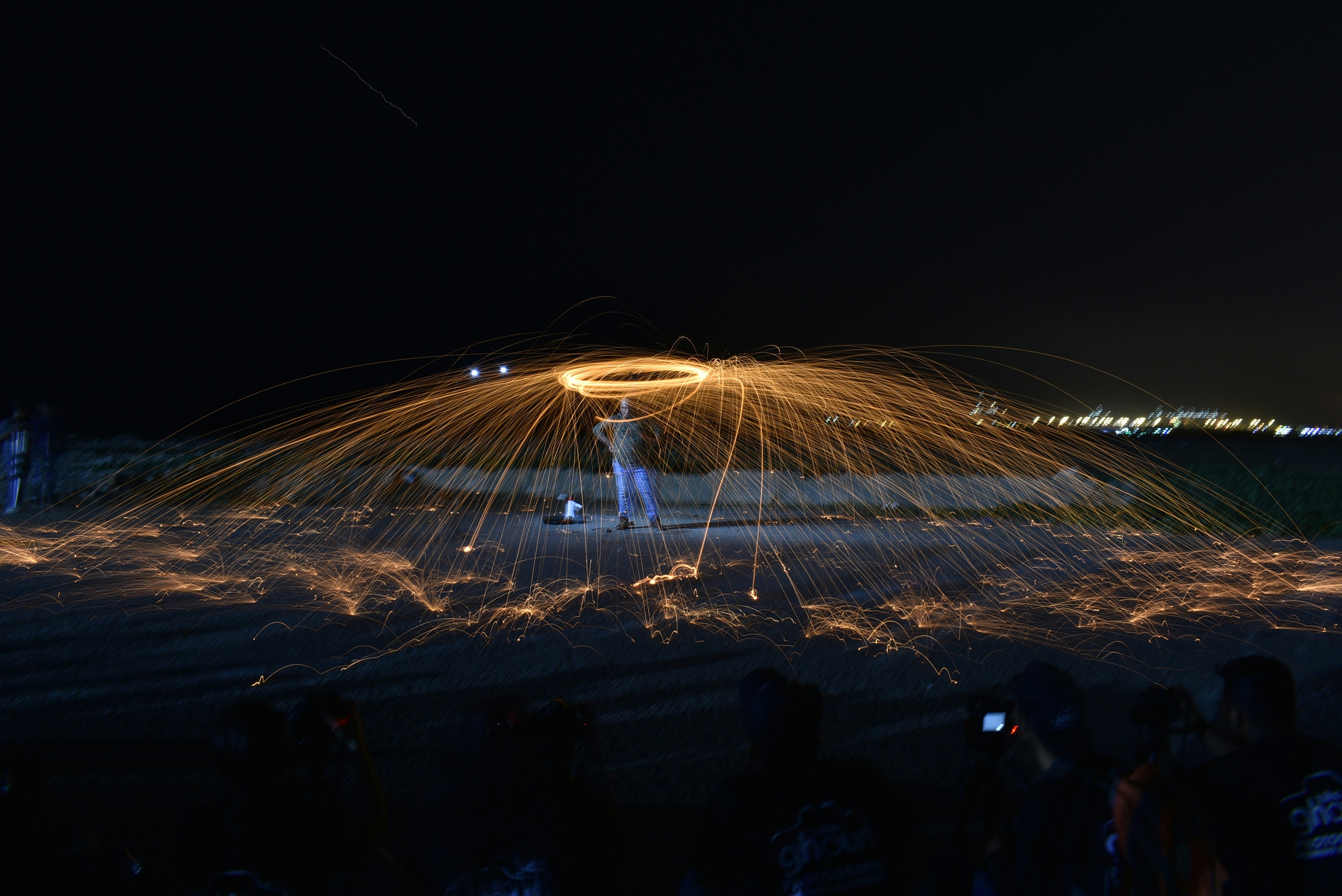 A man standing on top of a field covered in fire photo – Free Water ...