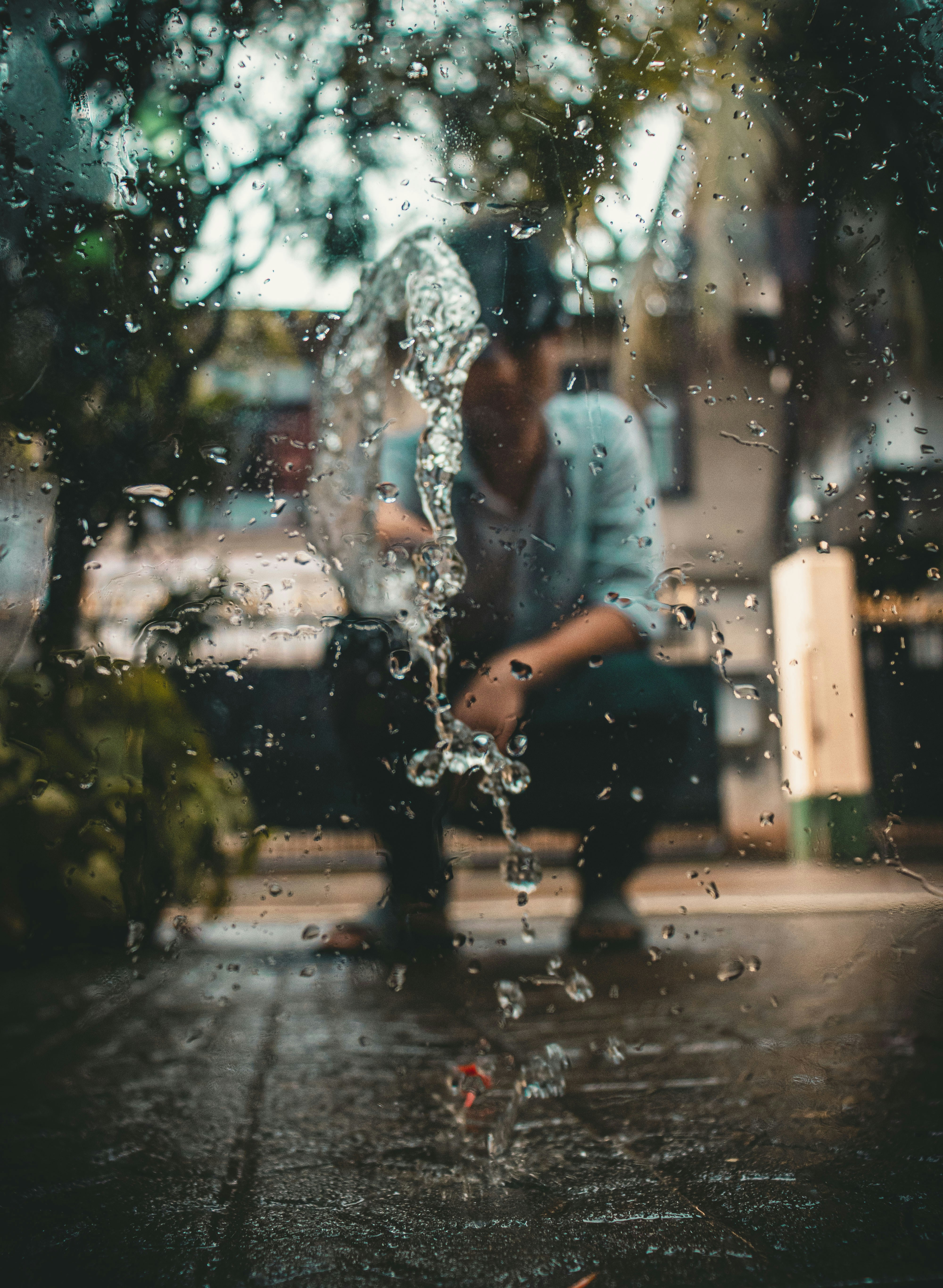 Center Splash Through Rain-Streaked Glass: A Quiet Urban Moment