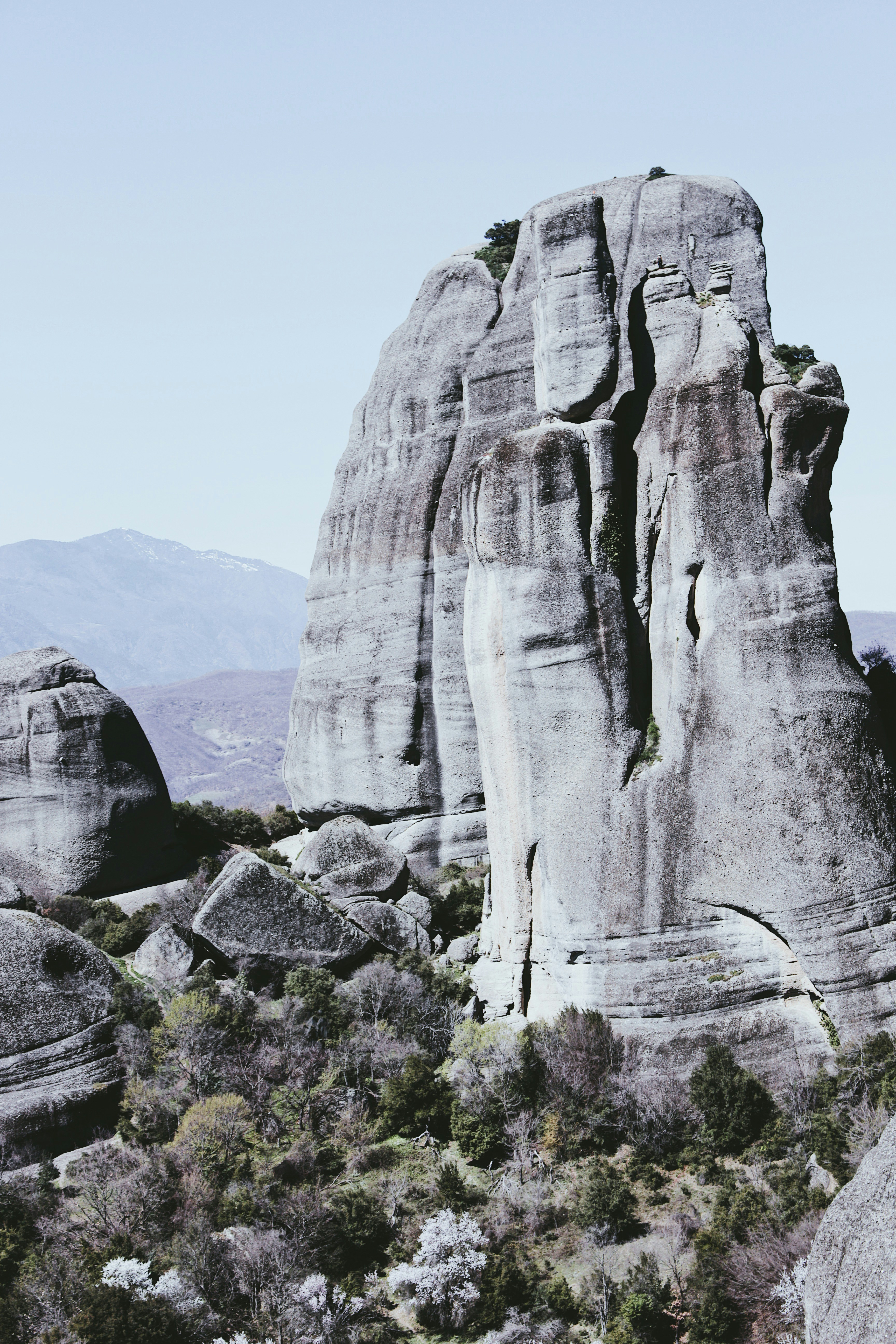 Monolithic Sentinel: Weathered Giants Rising from the Pine-Scattered Foothills