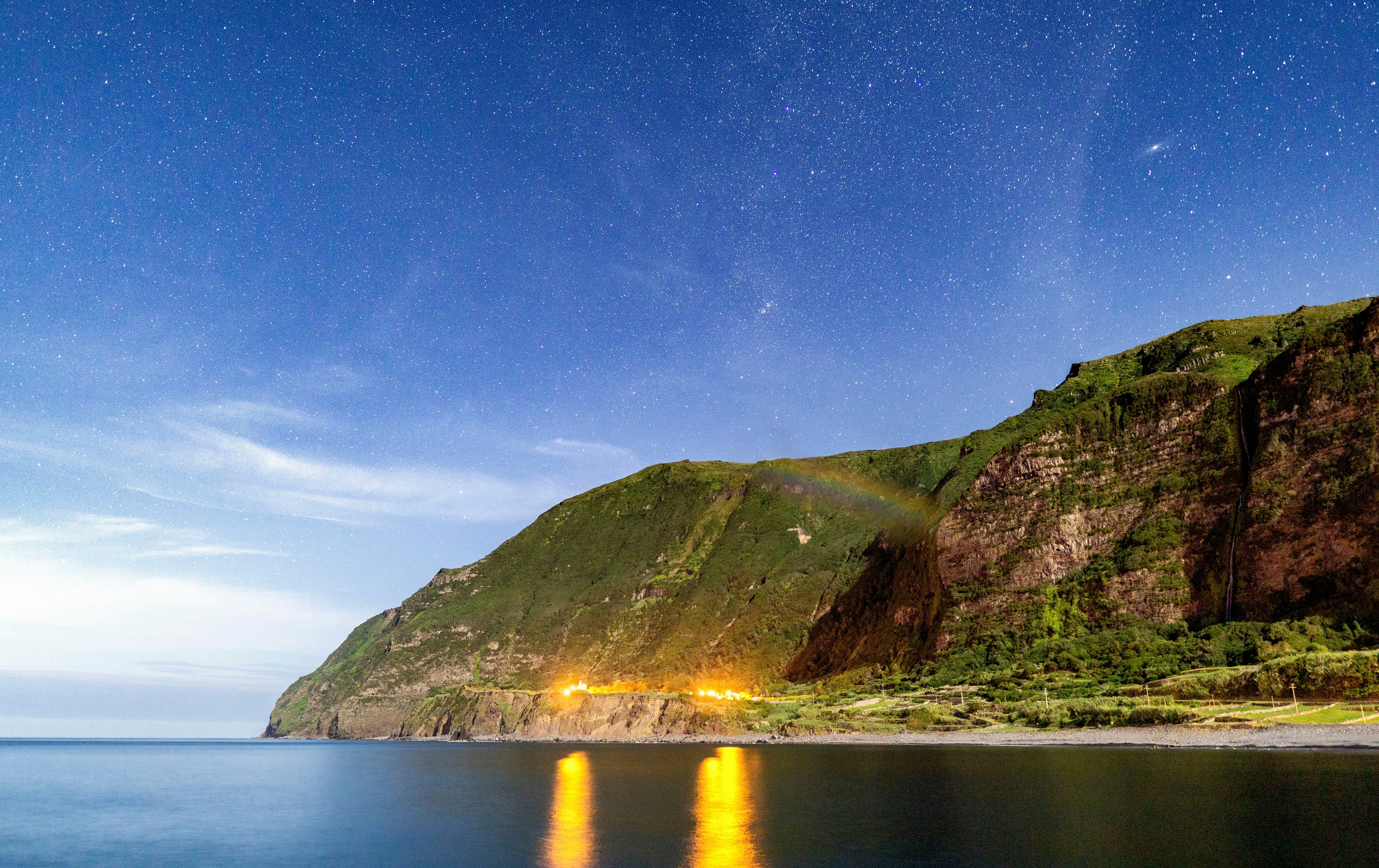 Starry Night Over a Luminous Cliffside