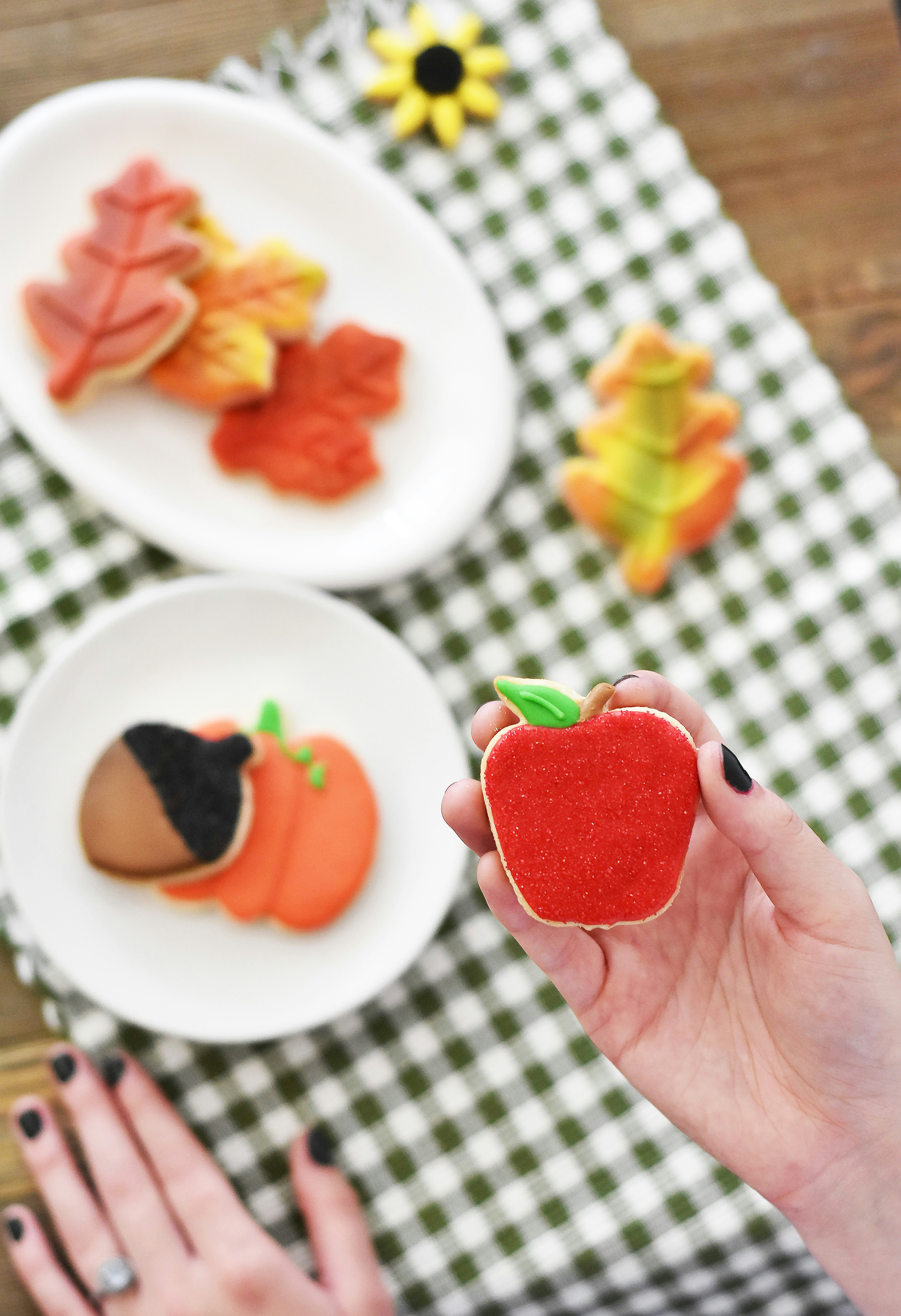 Crimson Apple Cookie in Hand Amid Harvest Cookie Spread
