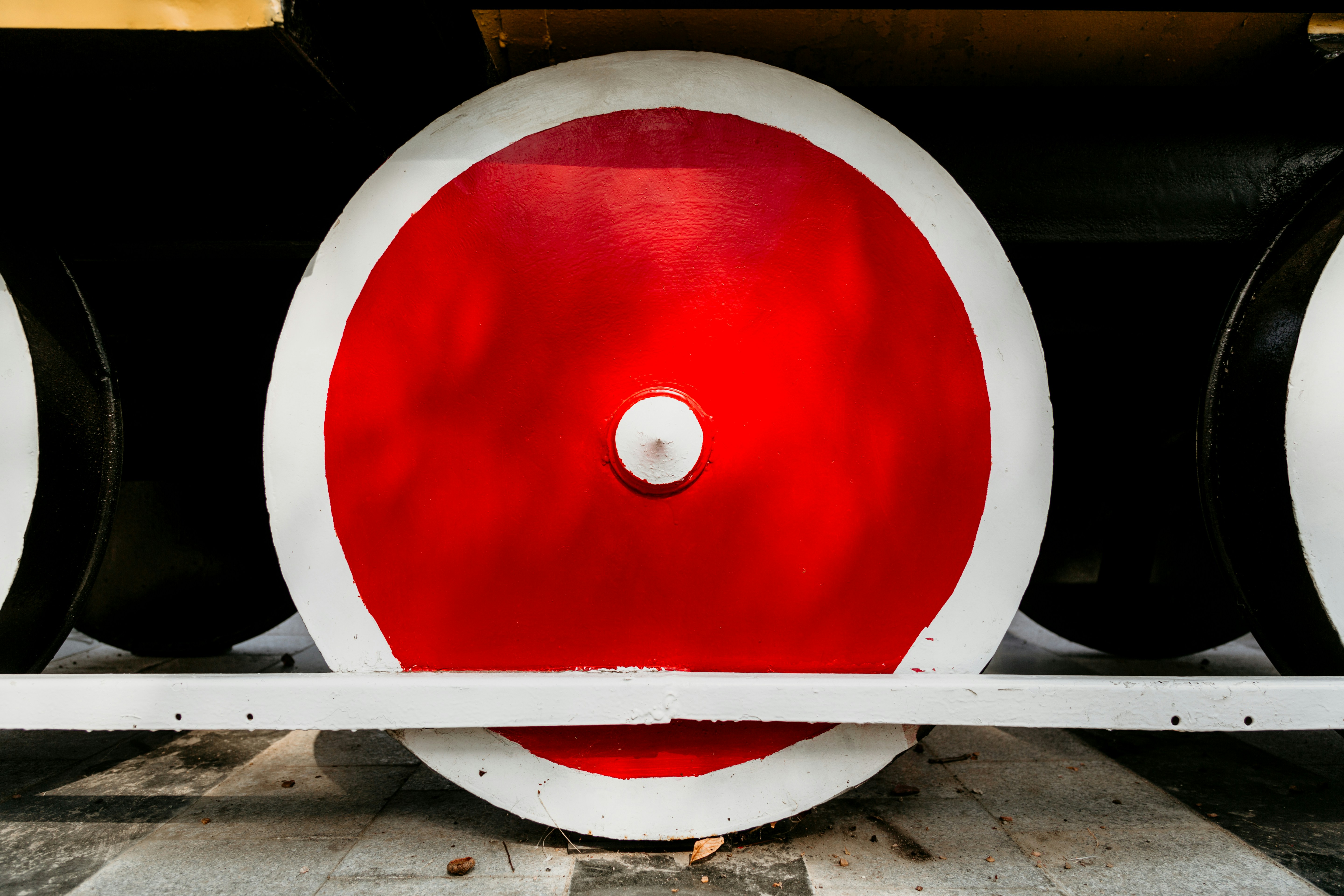 Crimson Stop Disk Between Rails: a close-up portrait of industrial color