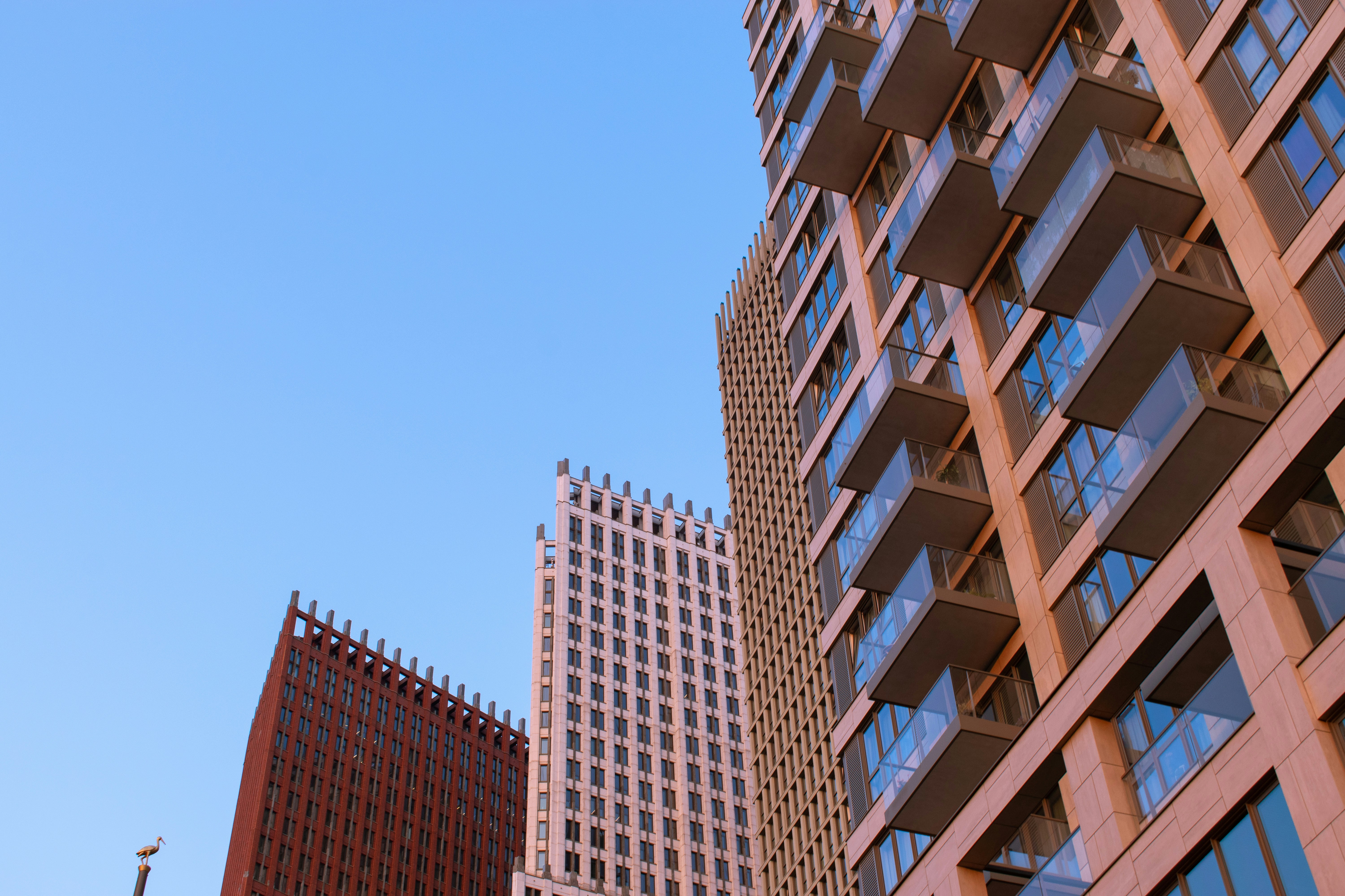 Vertical Echoes: Towers Reaching into a Blue City Sky