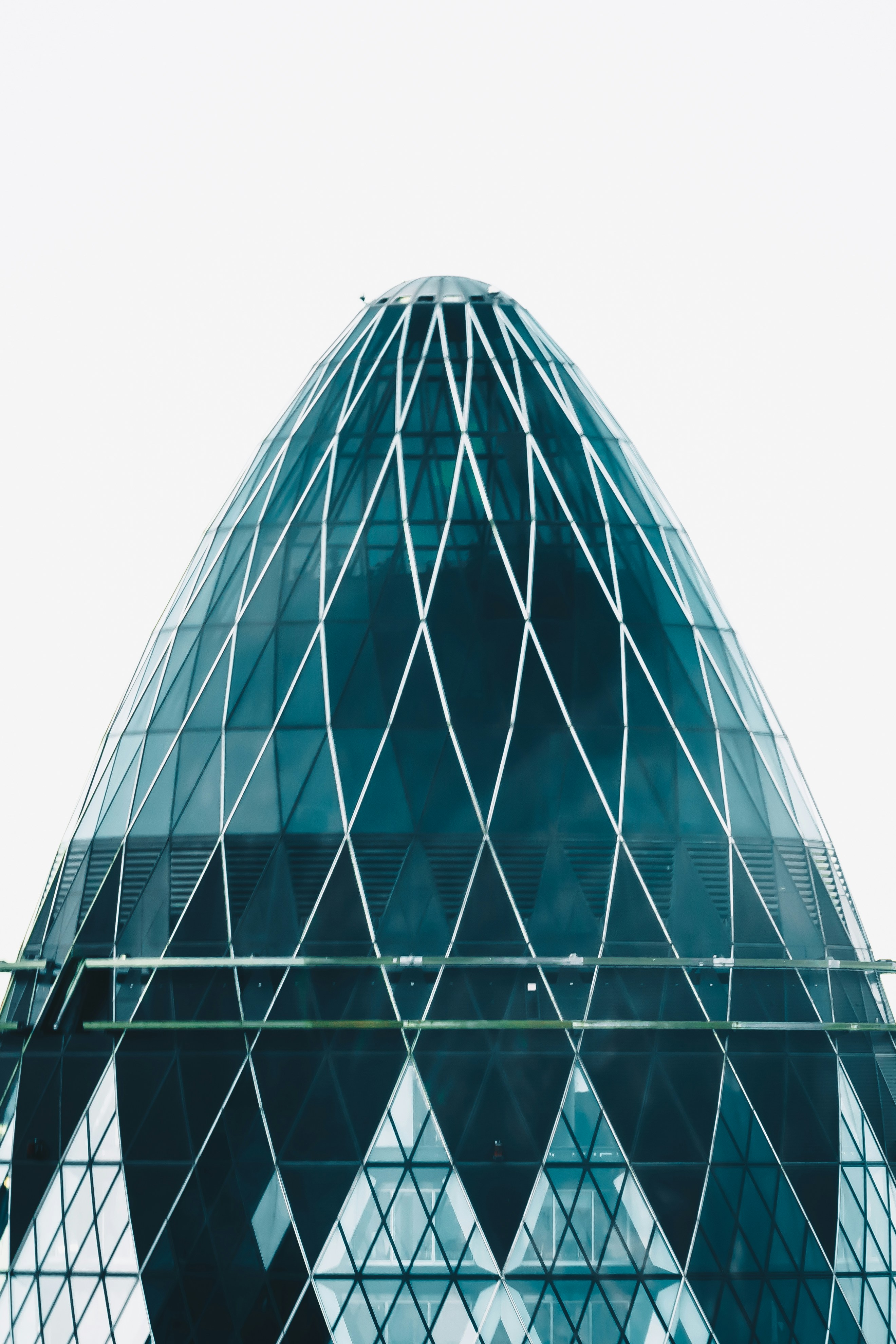 Facade of a Glass Diamond: The Gherkin-Inspired Shell Rising Above City Light