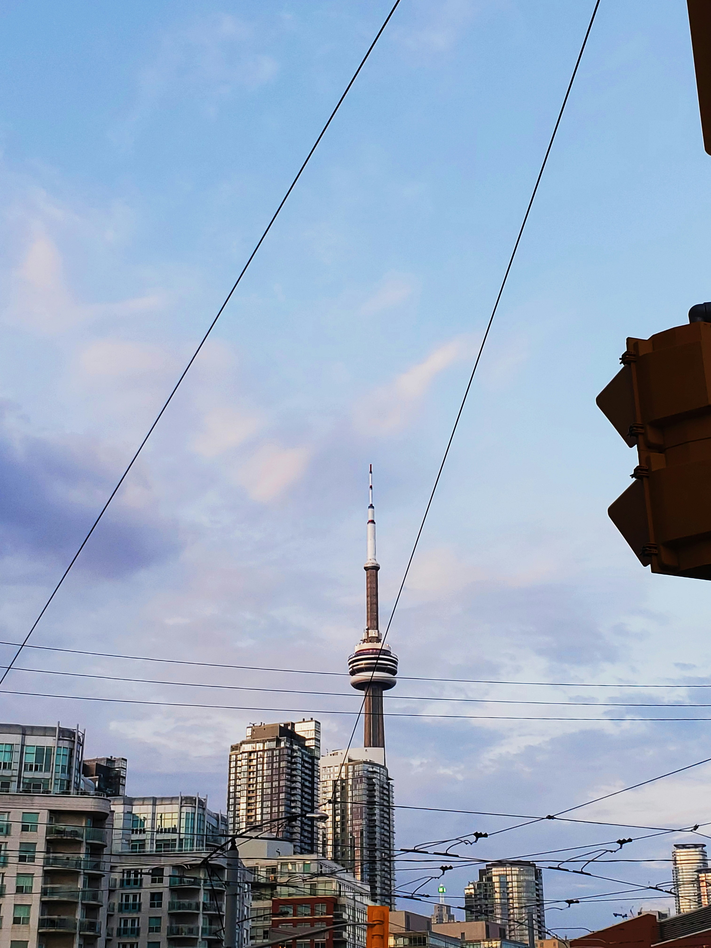 Threads of Light Over the Skyline: CN Tower Above a Web of Wires