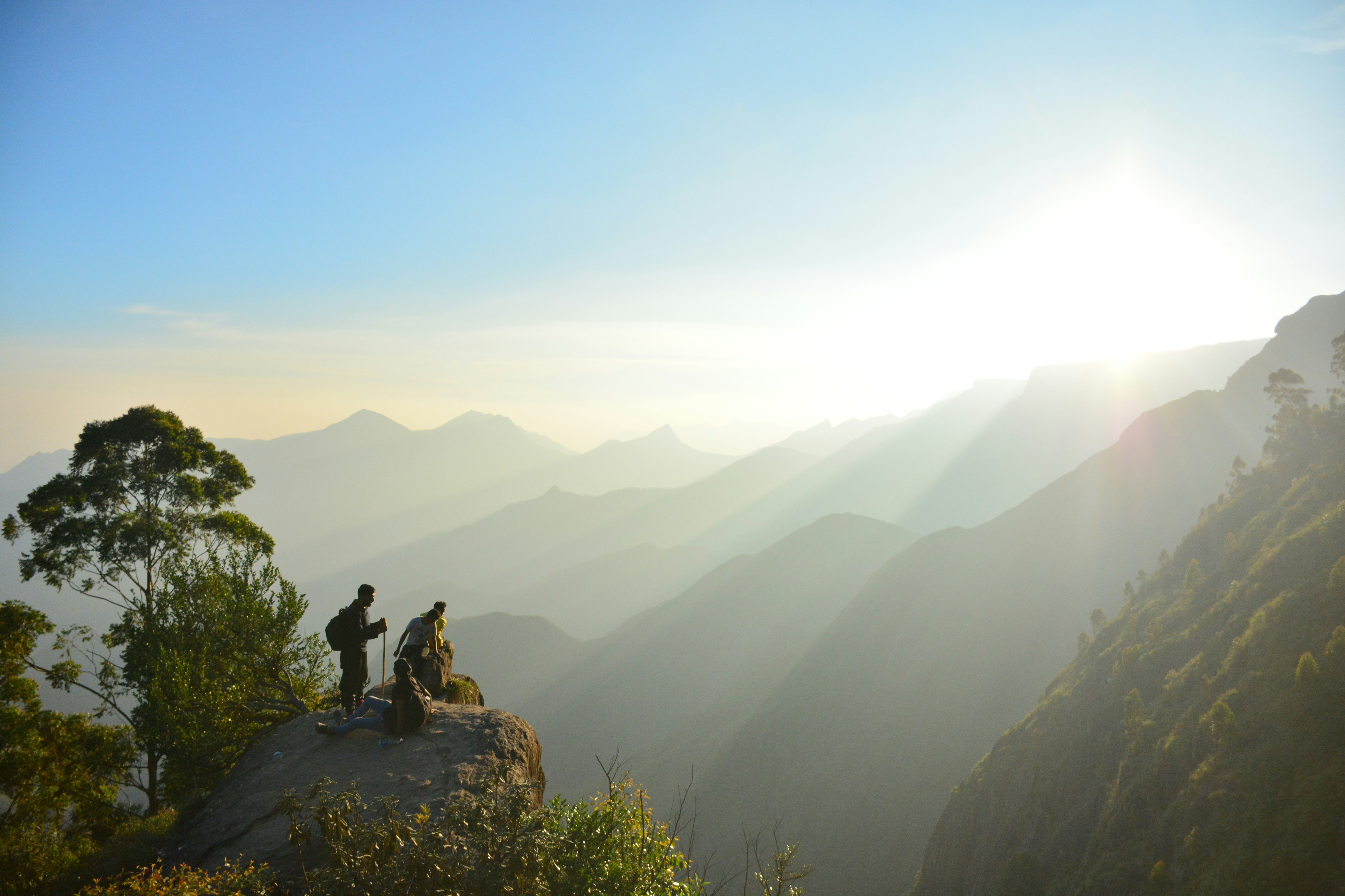 Aerial photo of man standing on cliff overlooking mountains photo ...