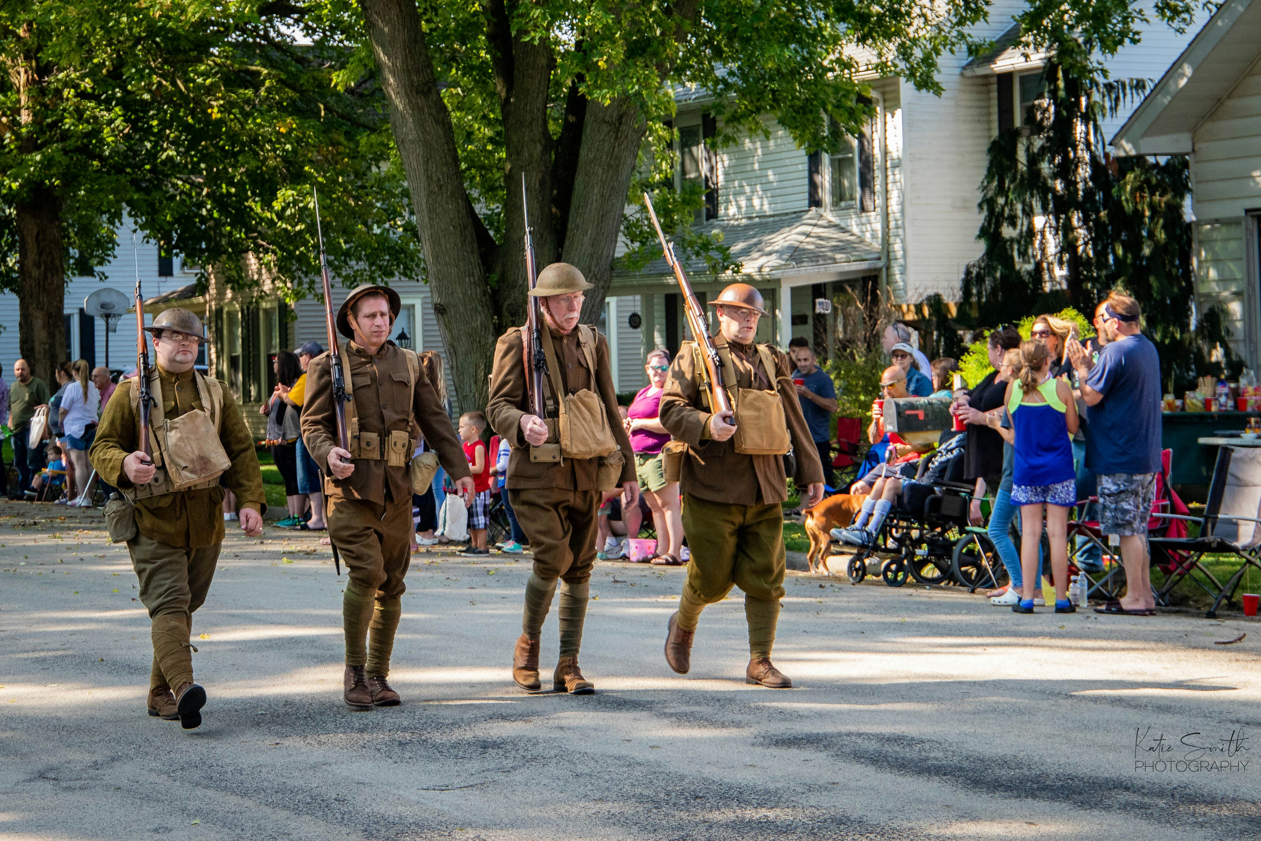 Four soldiers marching on road carrying rifles photo – Free Person ...