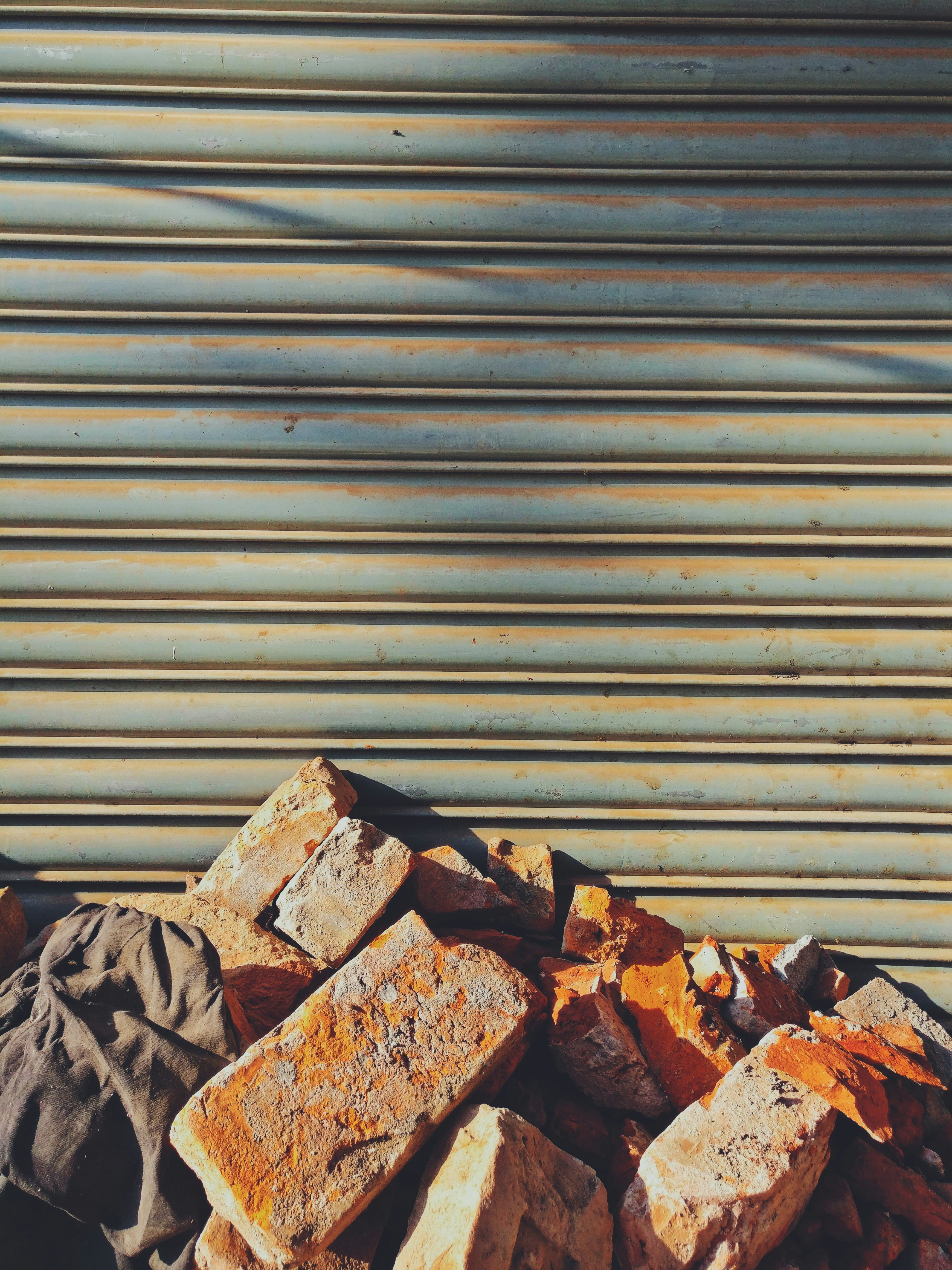 Rust and Rivets: Bricks at the Foot of a Closed Sighing Gate