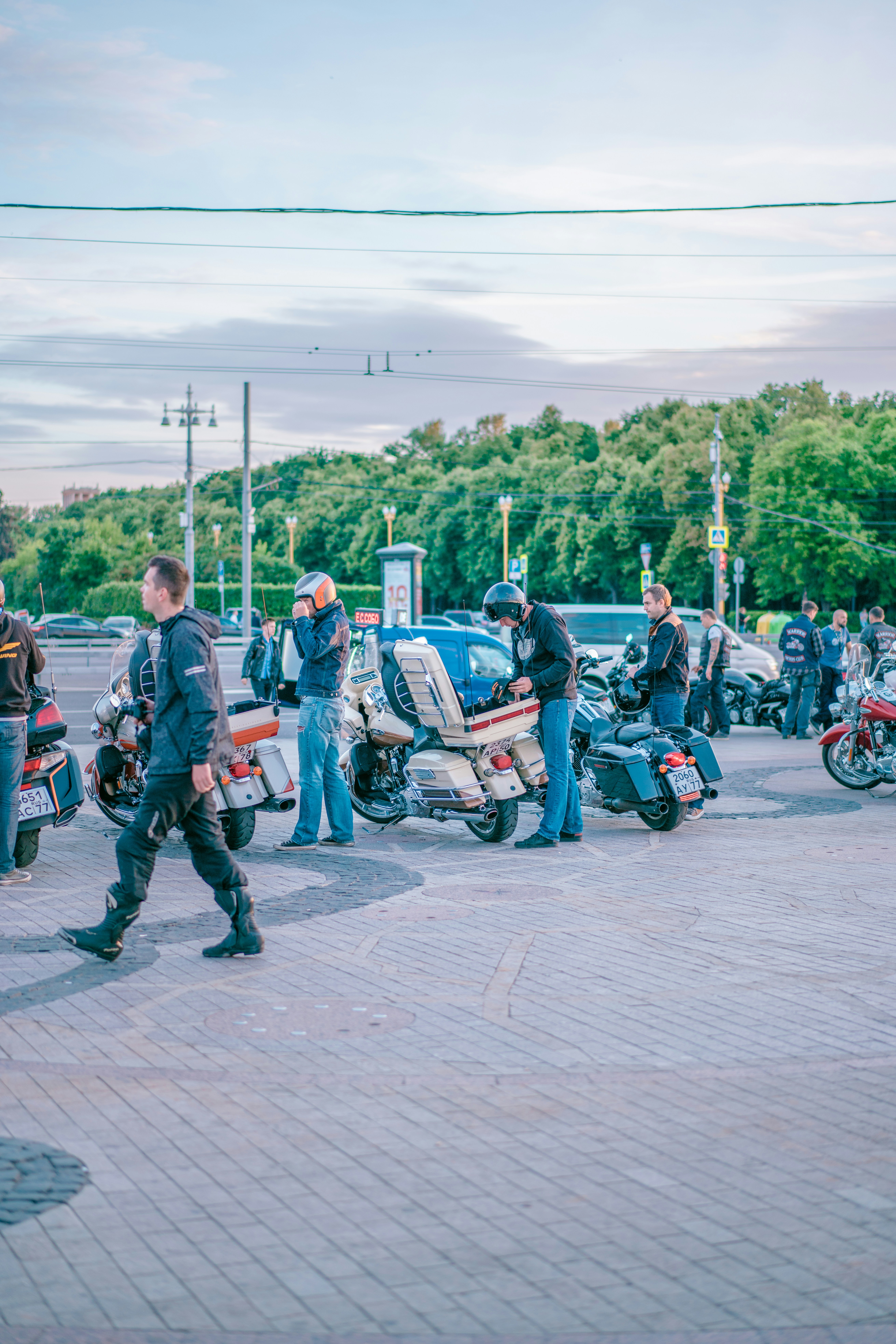 Chrome Pause in the City Square: Riders Gathered by Parked Motorcycles